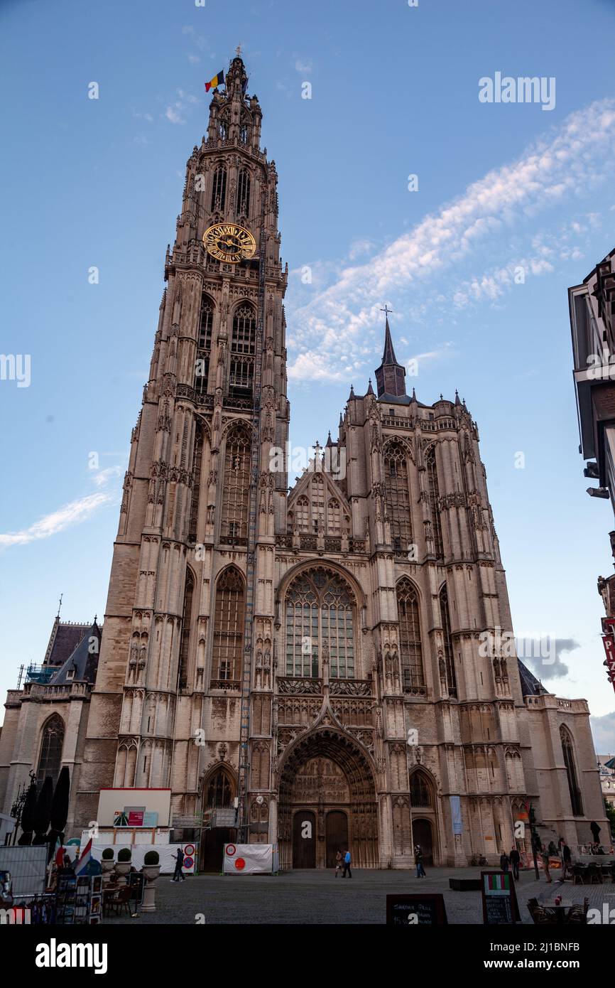 A vertical shot of the Cathedral of Our Lady of Antwerp against blue ...