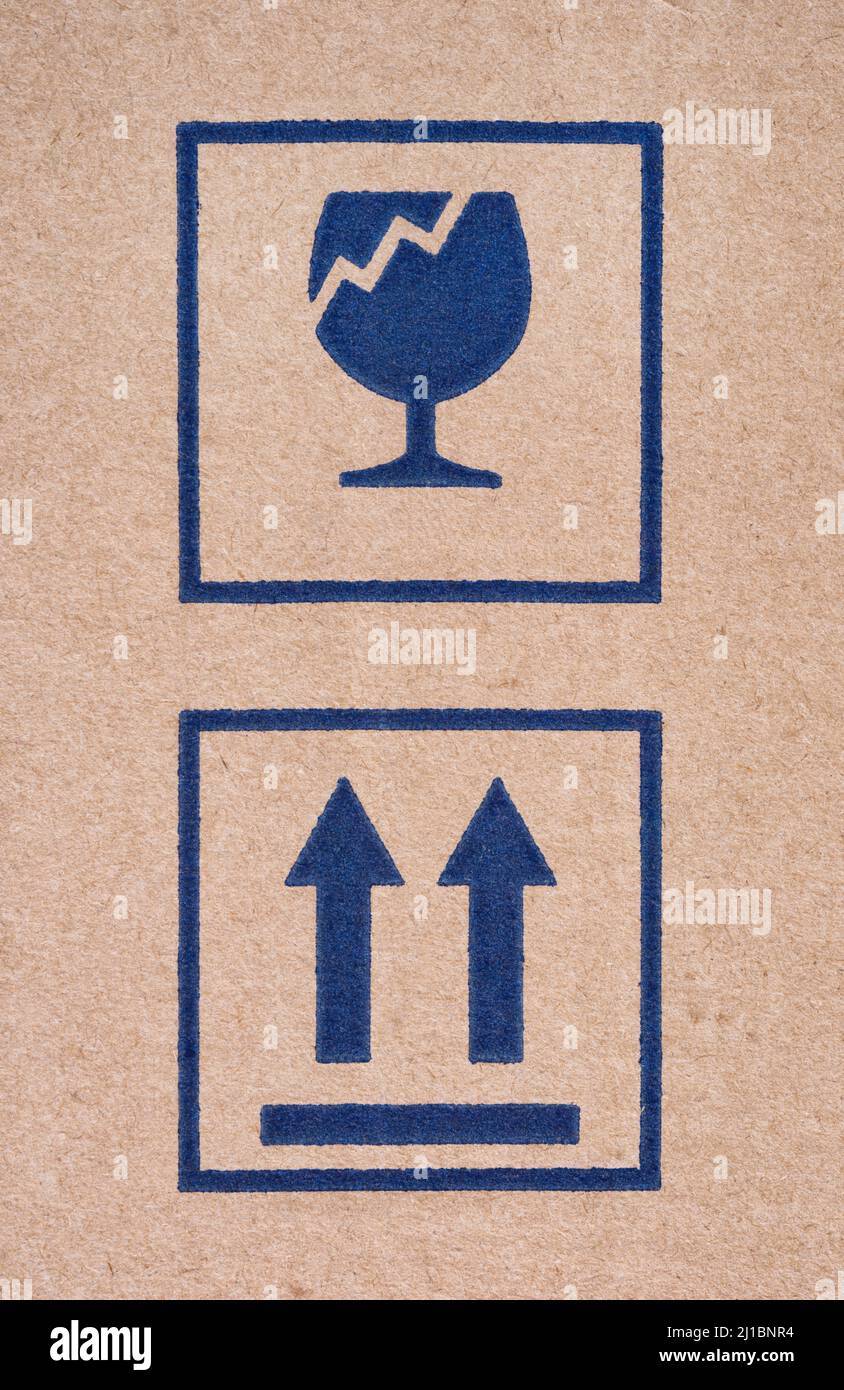 Two signs on cardboard box - Fragile and This Way Up. Close-up Stock ...