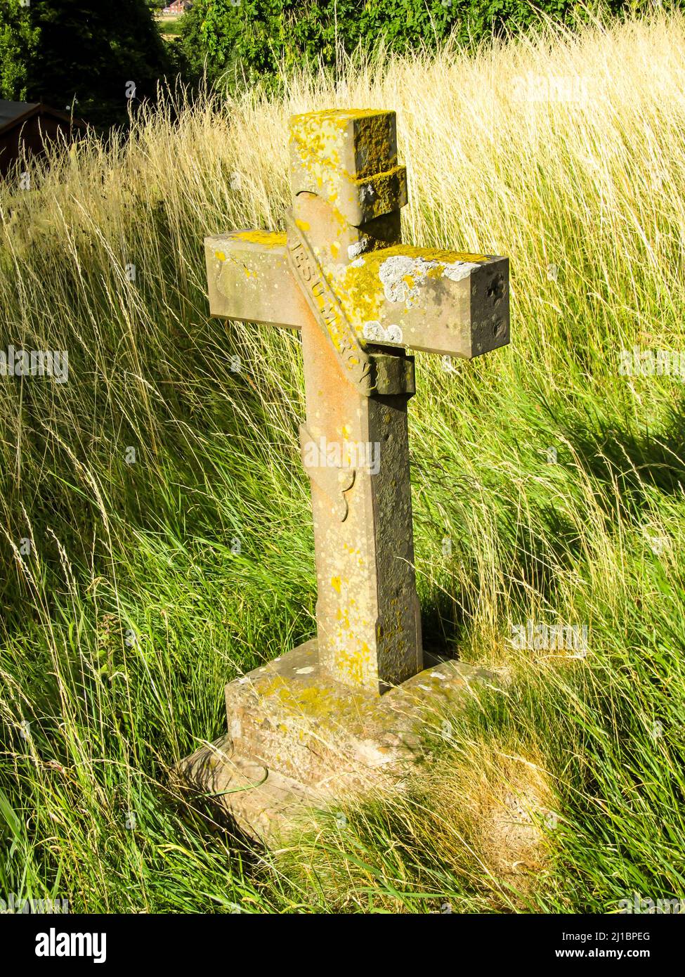 An old Lichen covered stone cross, Outside of the Parish Church of ...