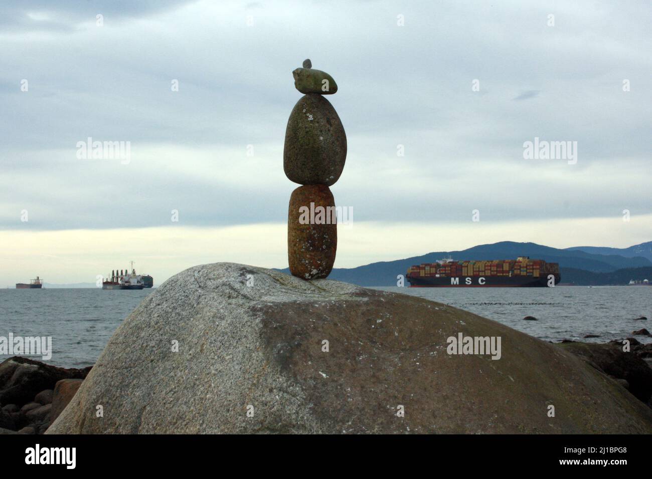 Standing, balancing rocks and English Bay with cargo ships in the ...