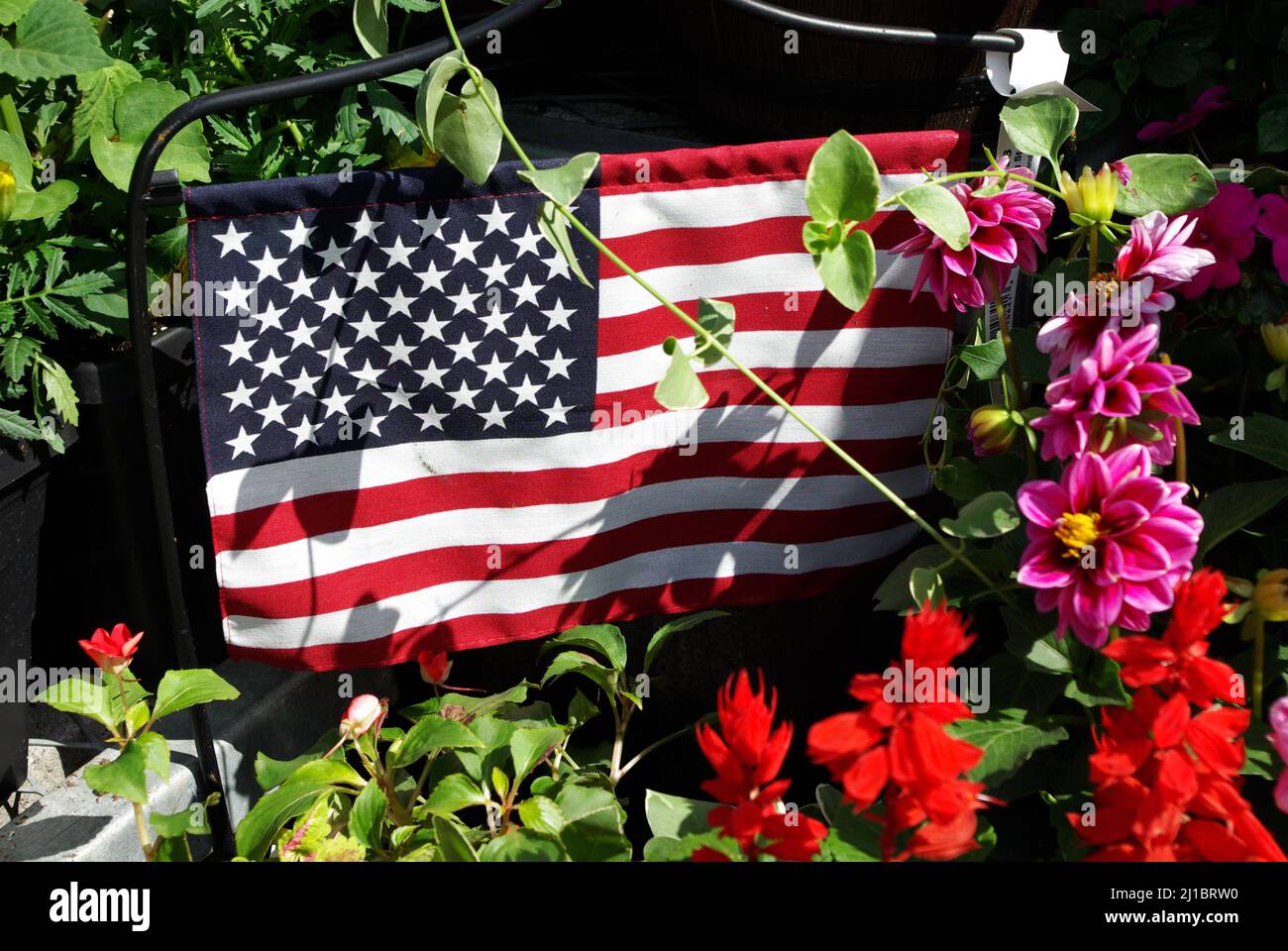 A close-up shot of an American flag hanging on a metallic carcass in ...