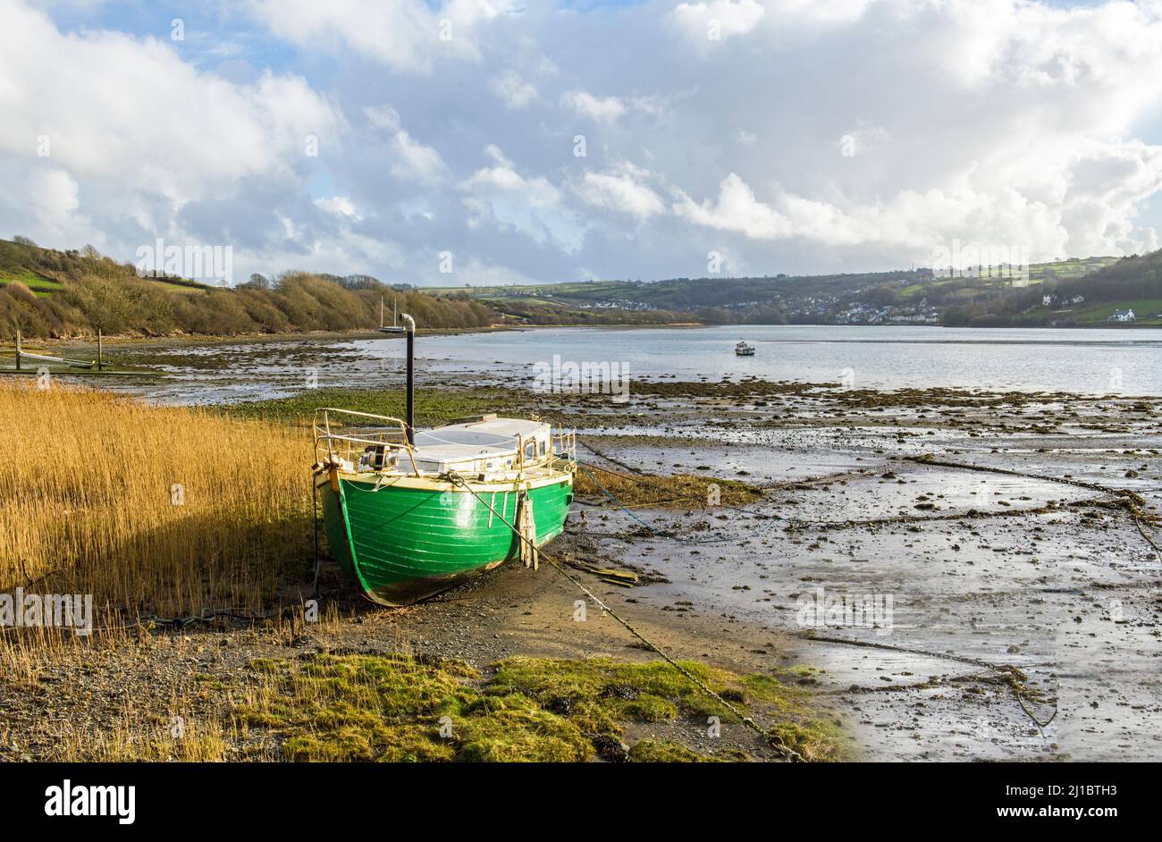 A green moored boat on the Teifi Estuary at Gwbert on Sea on the ...
