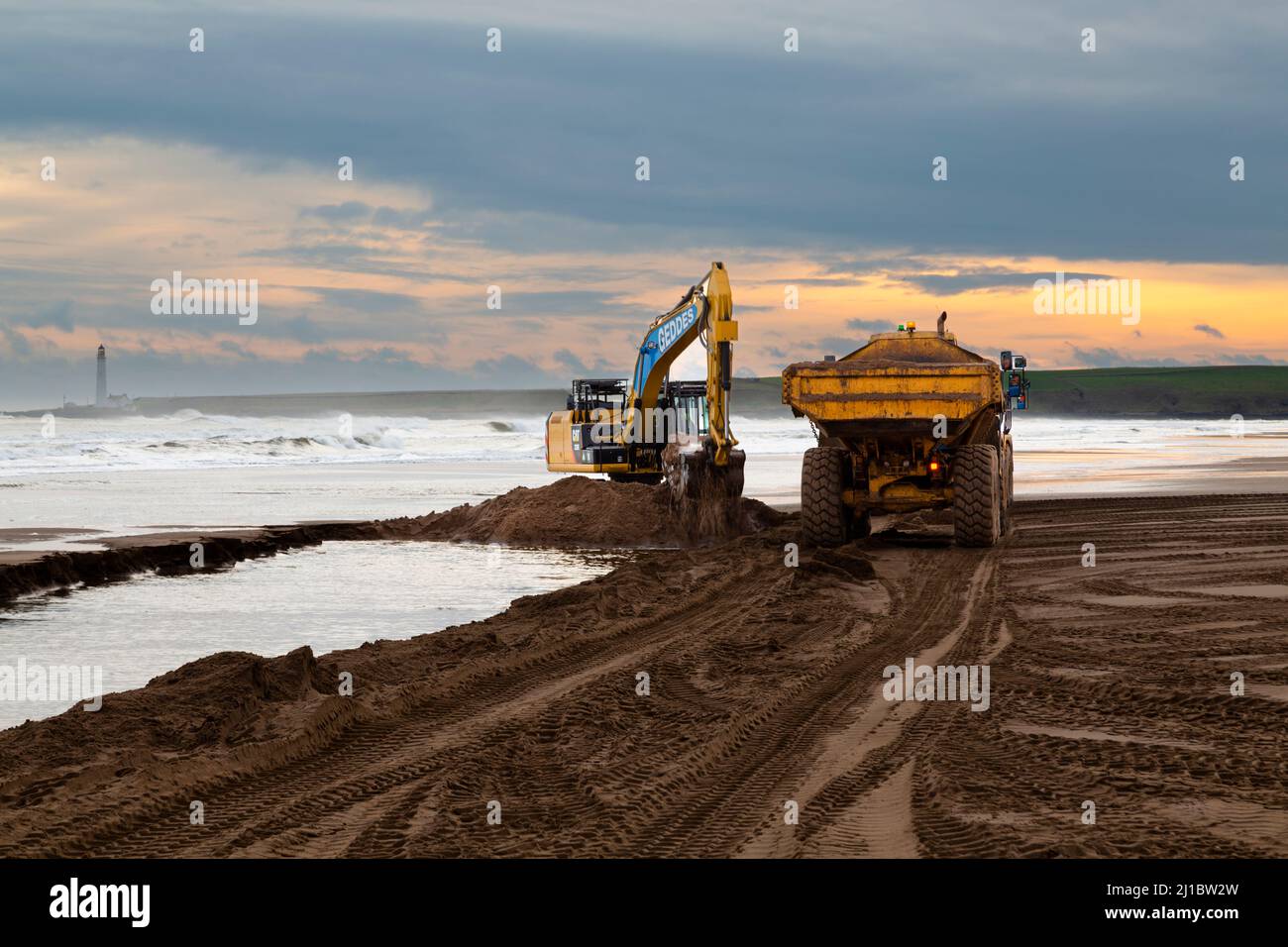 Digger and lorries on Montrose beach in Scotland as part of works to ...