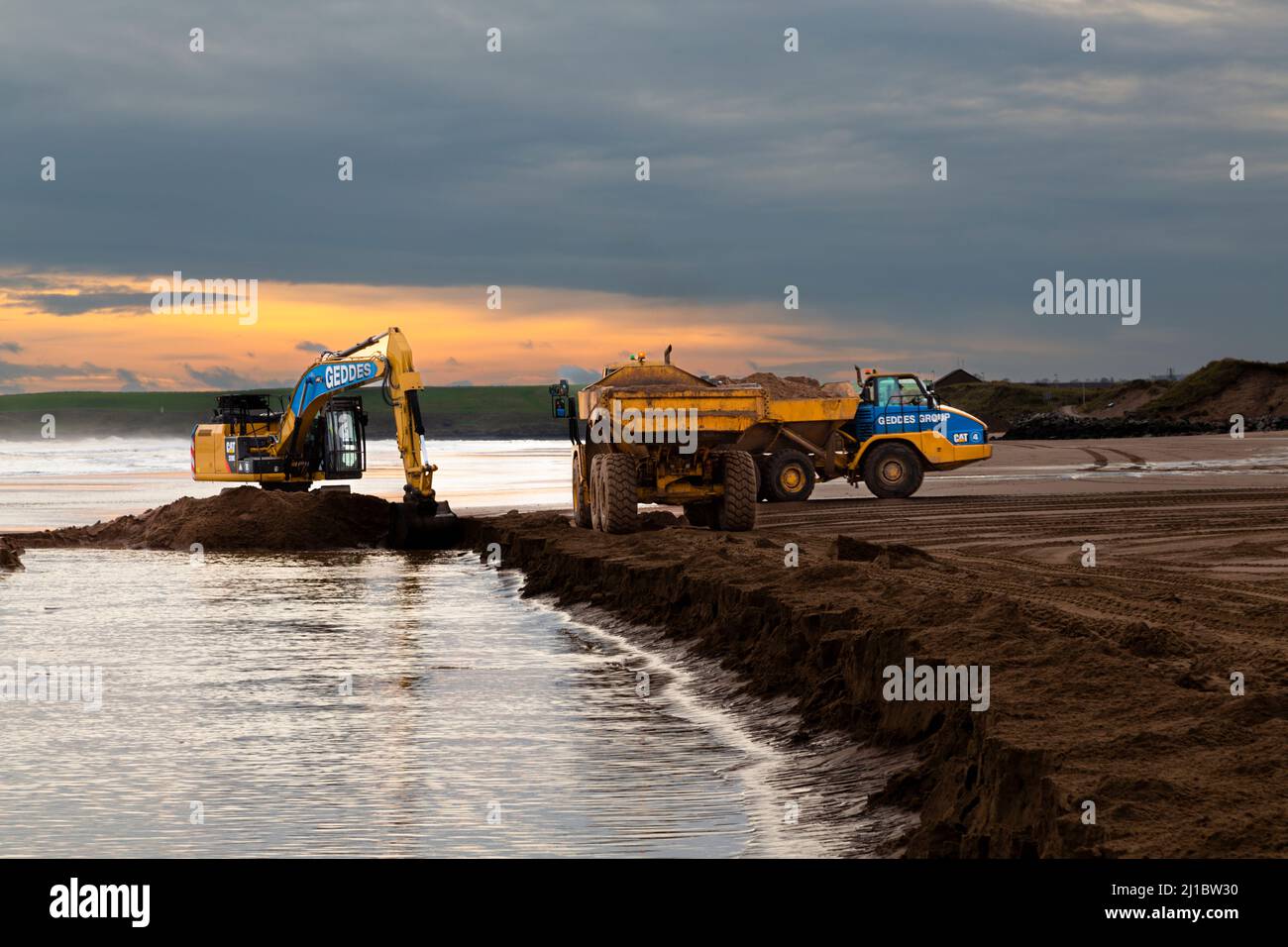 Digger and lorries on Montrose beach in Scotland as part of works to ...