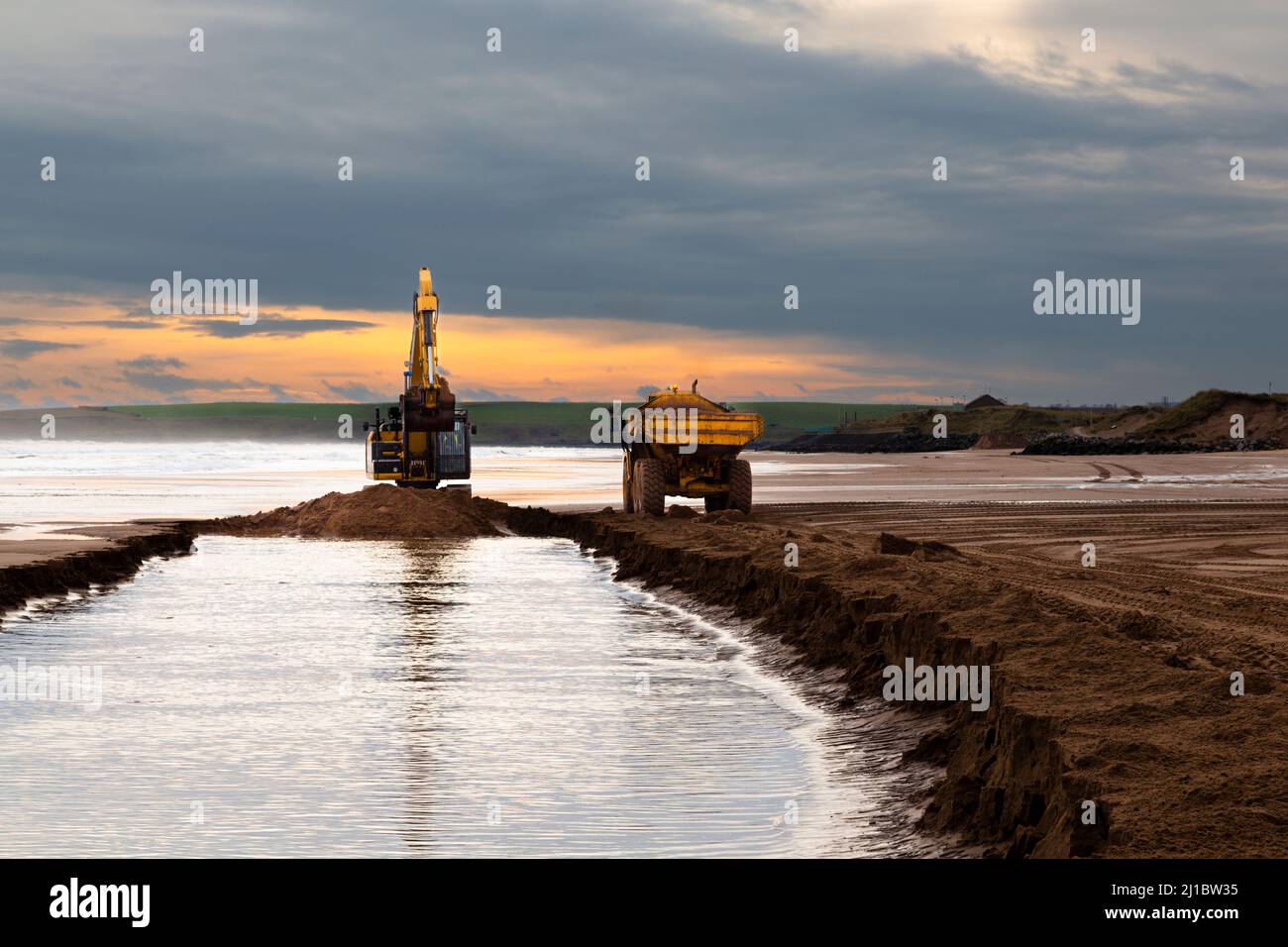 Digger and lorries on Montrose beach in Scotland as part of works to ...