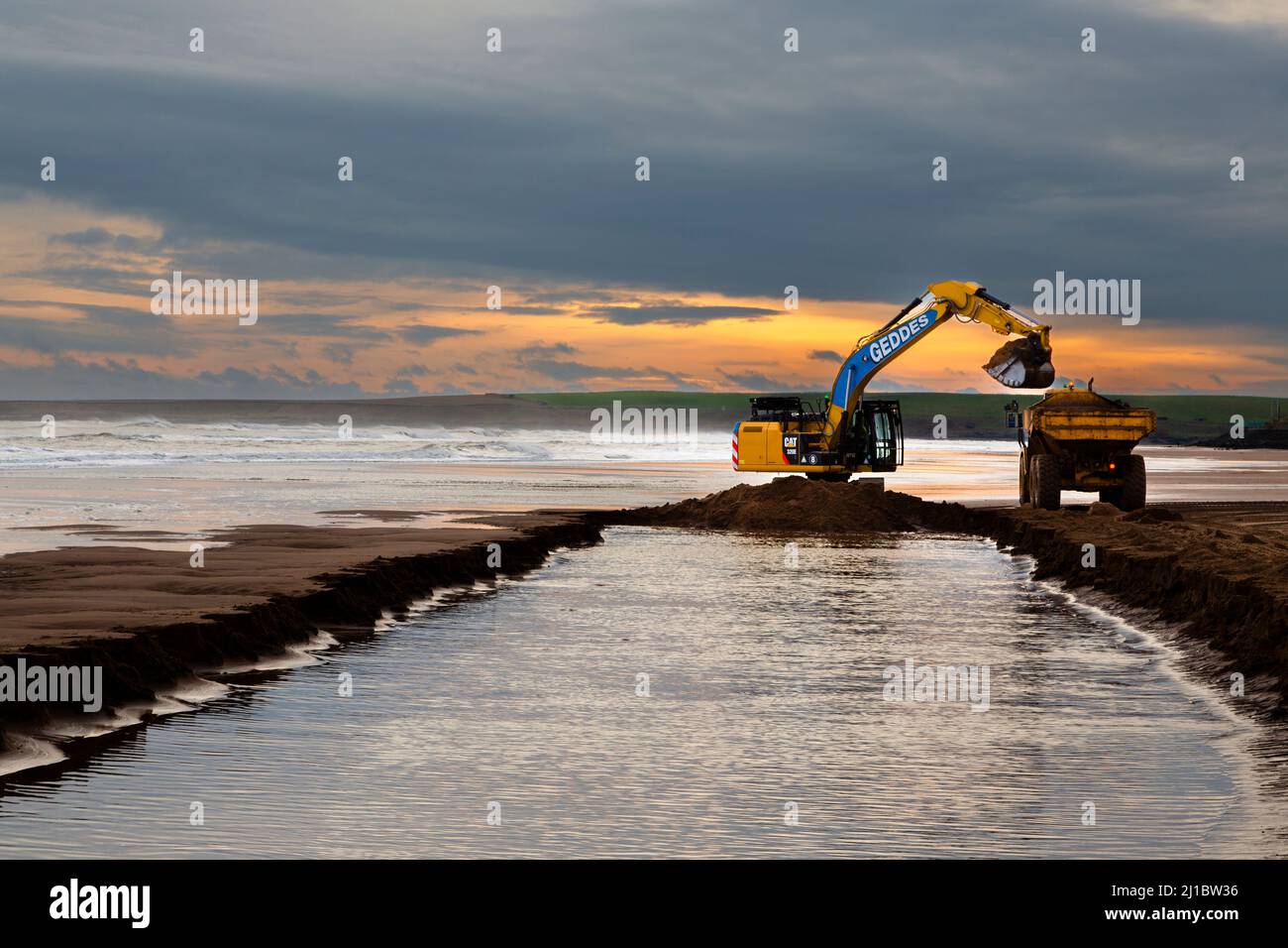Digger and lorries on Montrose beach in Scotland as part of works to ...