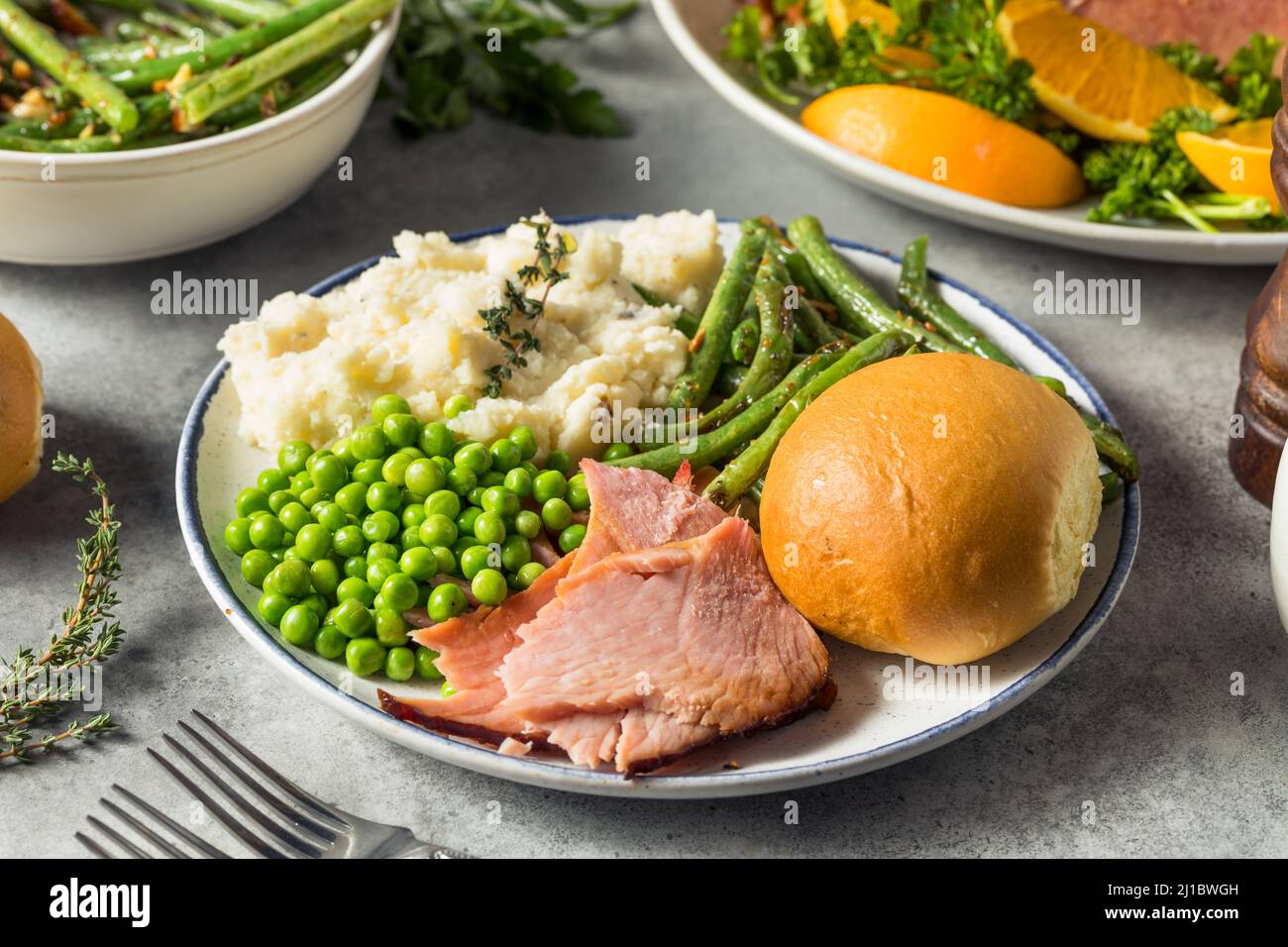 Homemade Easter Ham Dinner with Pototoes Beans and Peas Stock Photo - Alamy