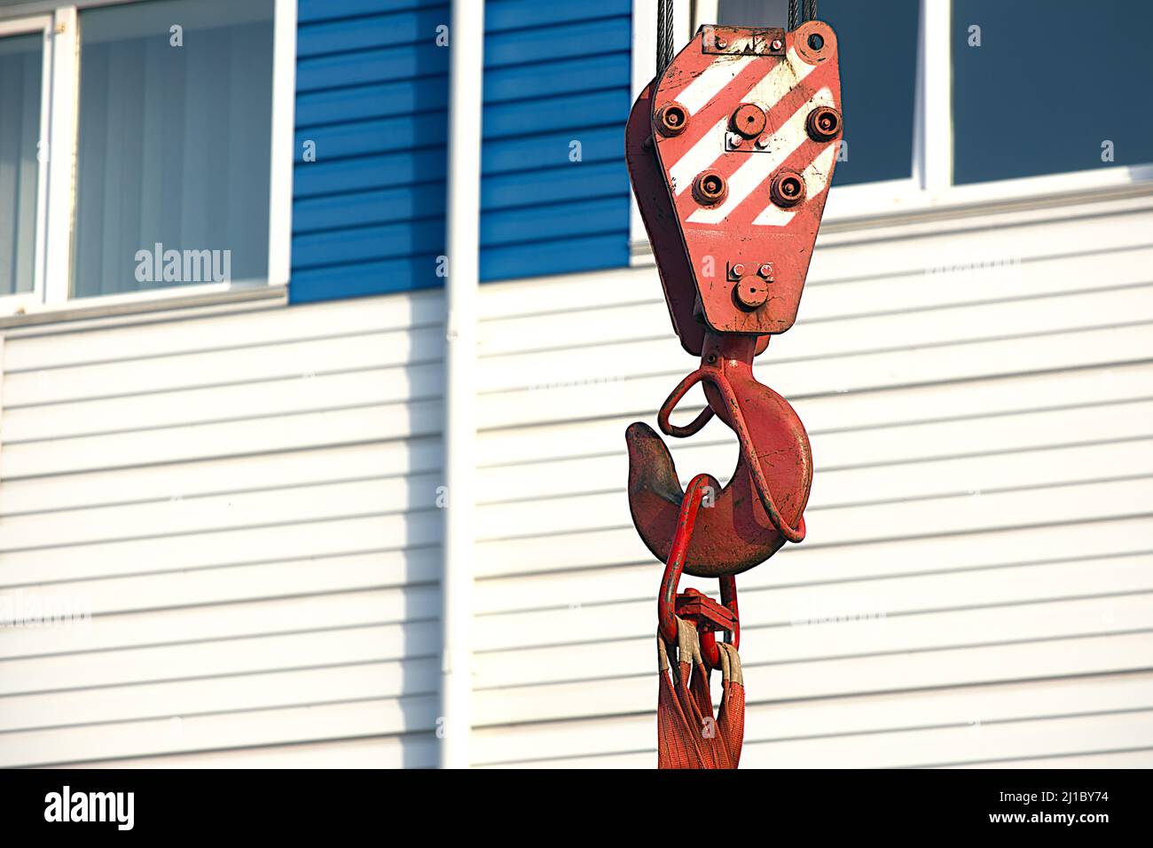 Hook of crane of lifting mechanism close-up. Lifting load to height in ...