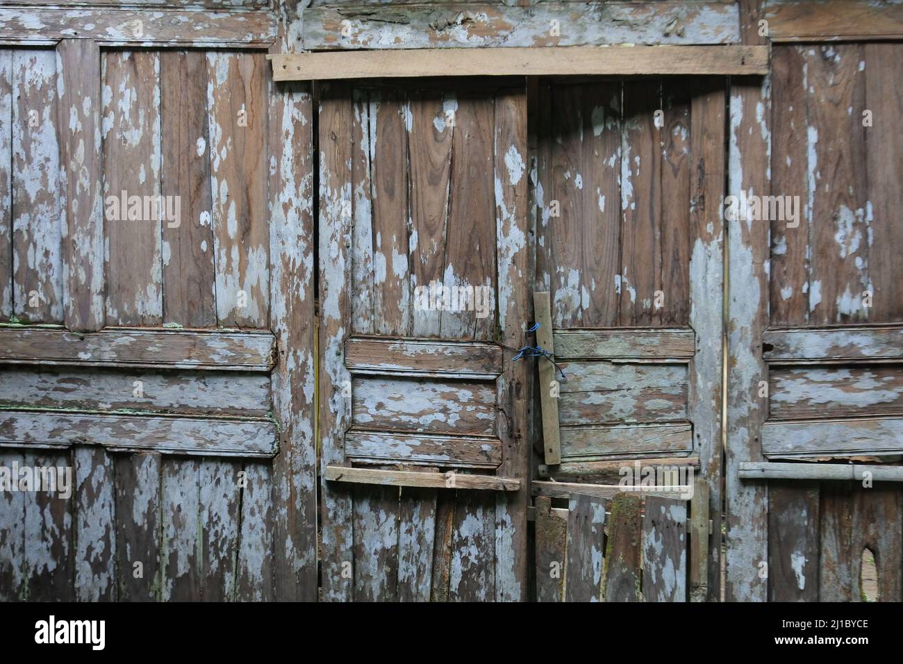 A closeup shot of an old aged door of a small wooden house Stock Photo ...