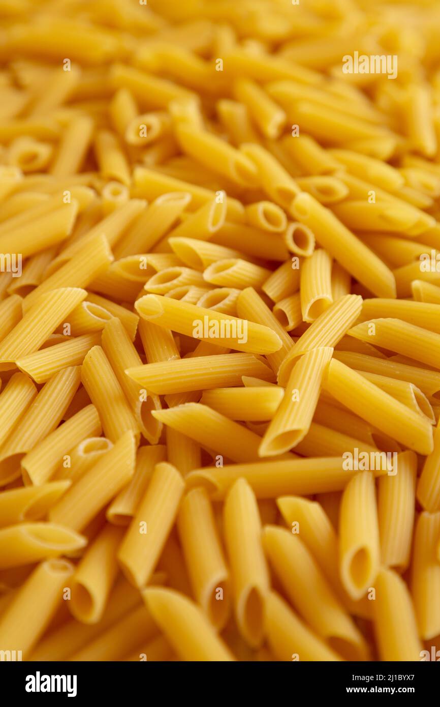 Homemade Raw Dry Penne Pasta, side view Stock Photo - Alamy