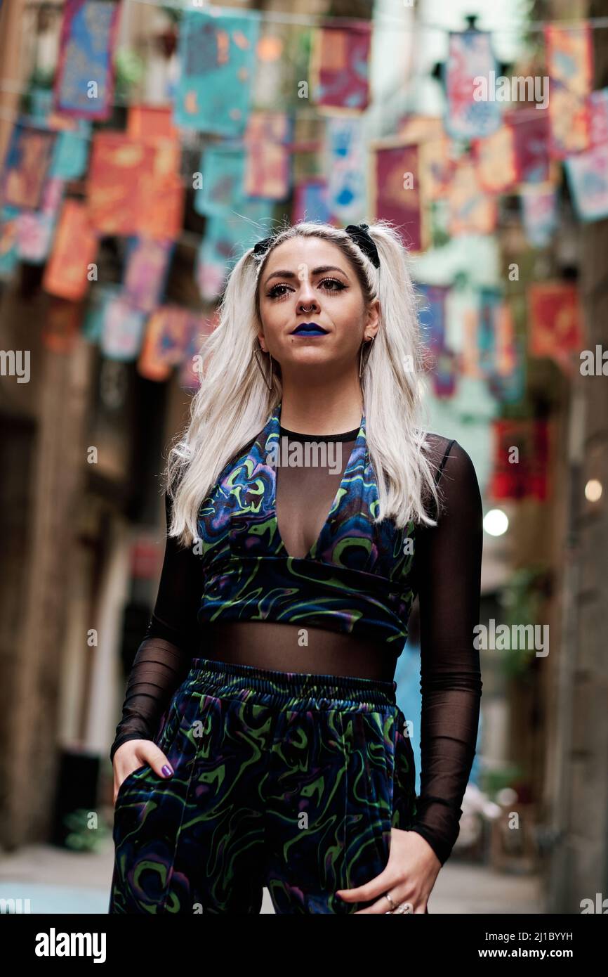 Alternative woman looking away while posing outdoors in the street ...