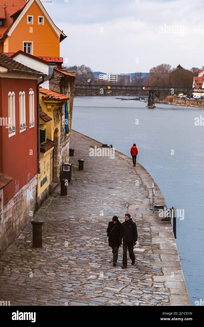 The bay of River Danube in Regensburg, Germany with walking people and ...