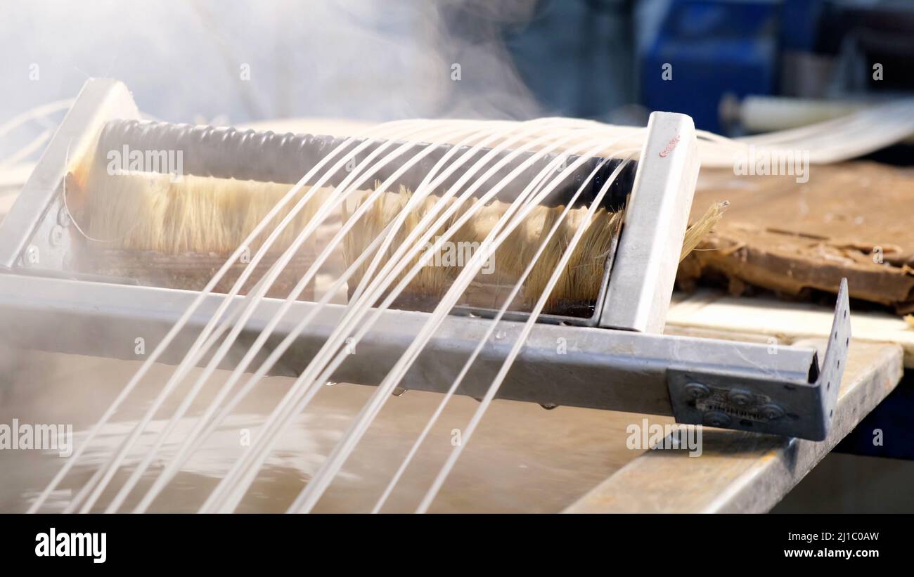 Recycled molten plastic comes out of the extruder machine Concept of ...