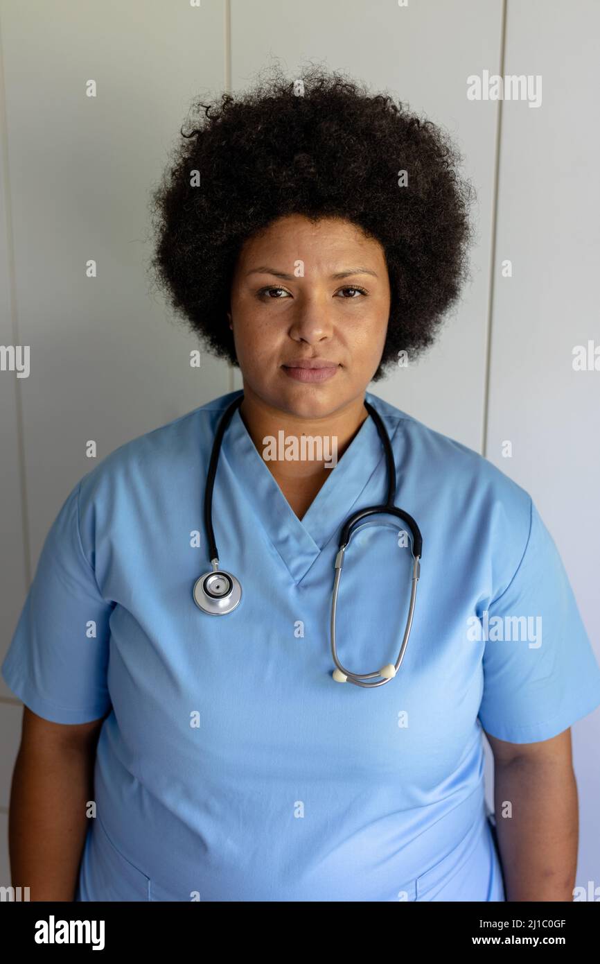 Portrait of confident african american mid adult female nurse with ...