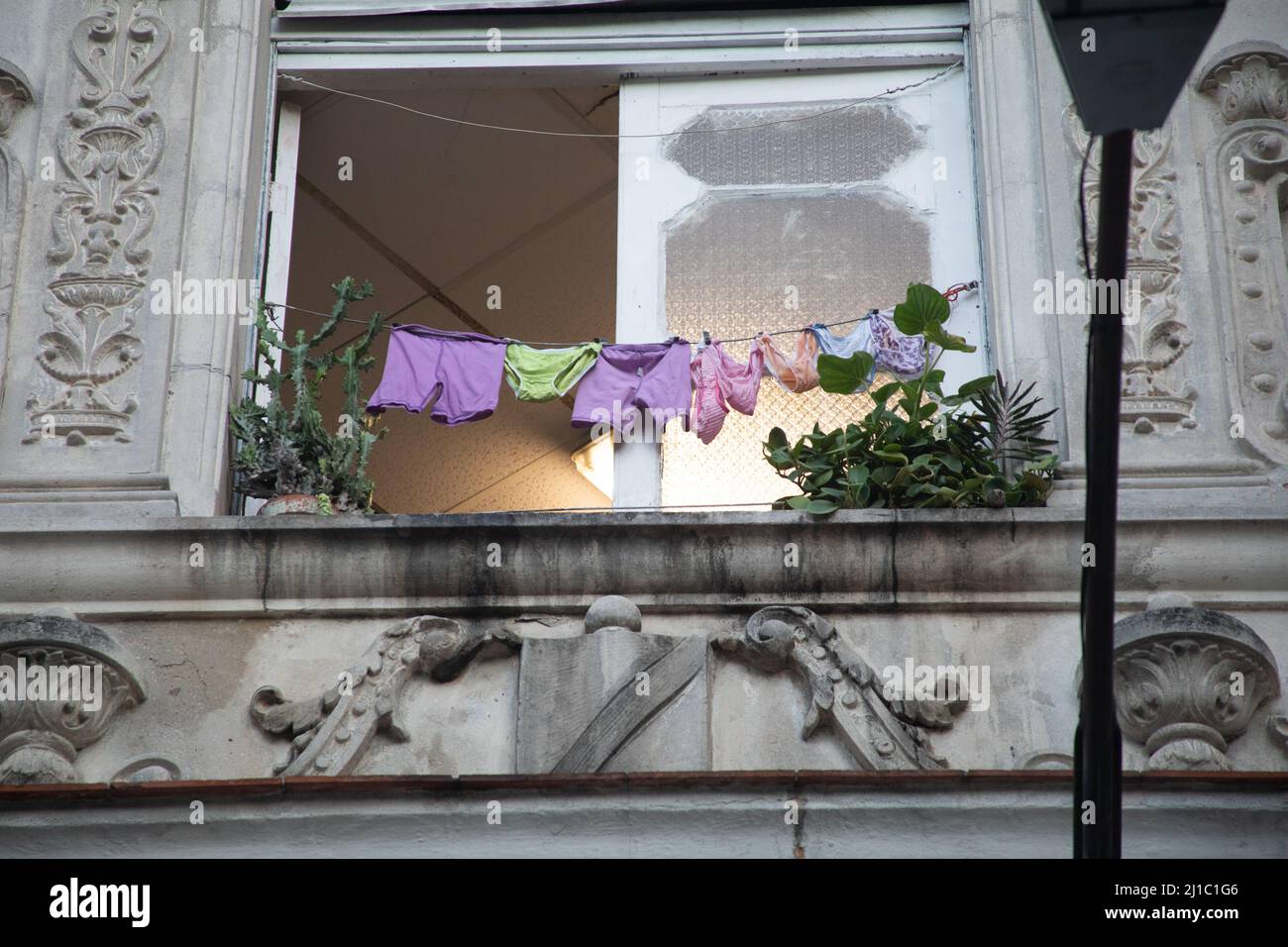A closeup of Drying clothes on a window string Stock Photo - Alamy