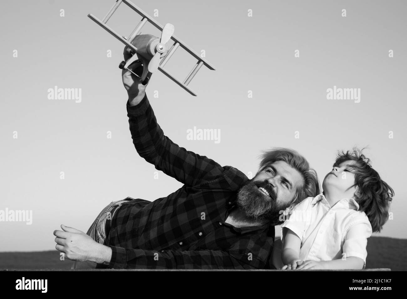 Father and son. Child pilot aviator with airplane dreams of traveling ...