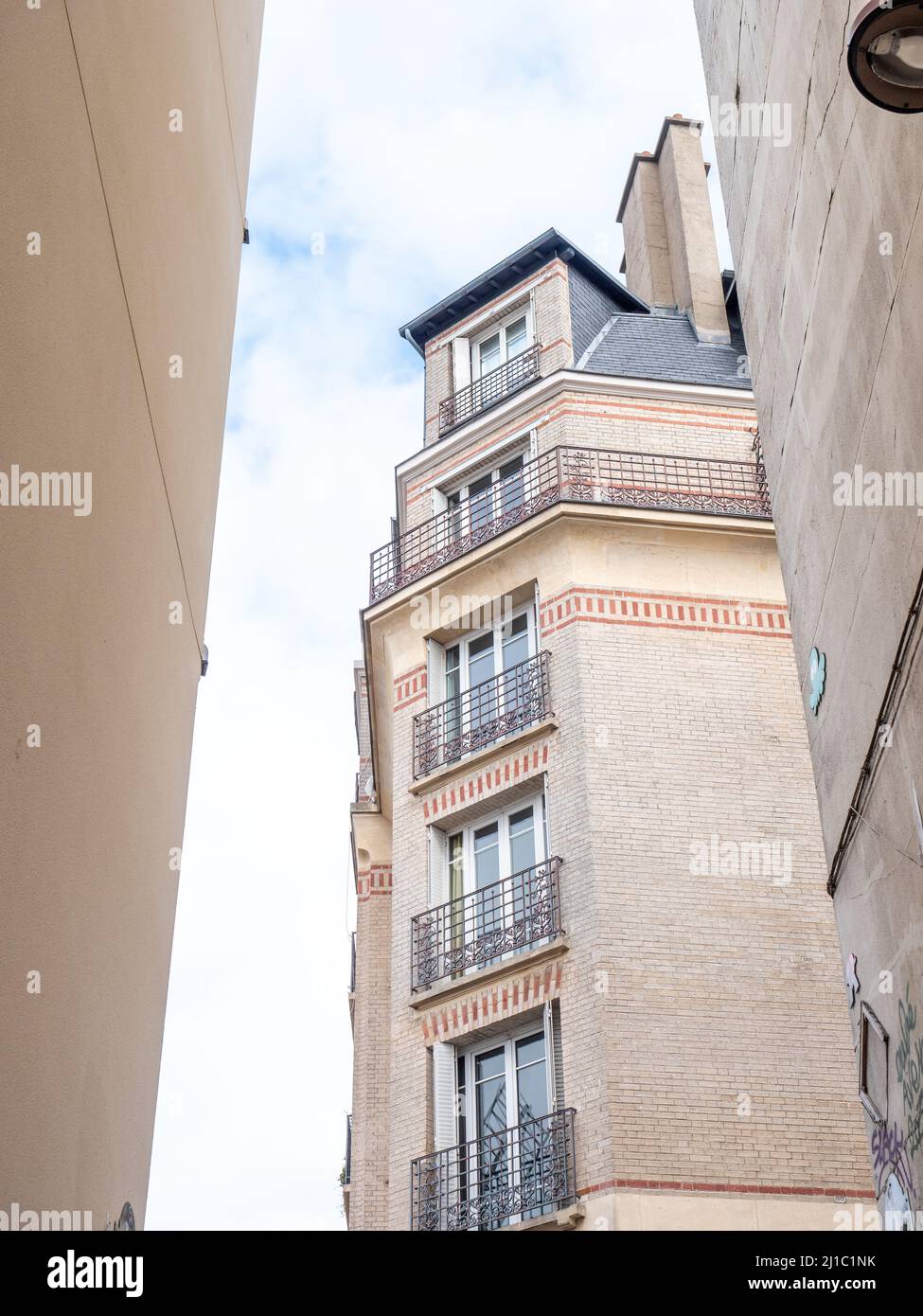 A vertical shot of a beautiful modern building with a blue roof under a ...