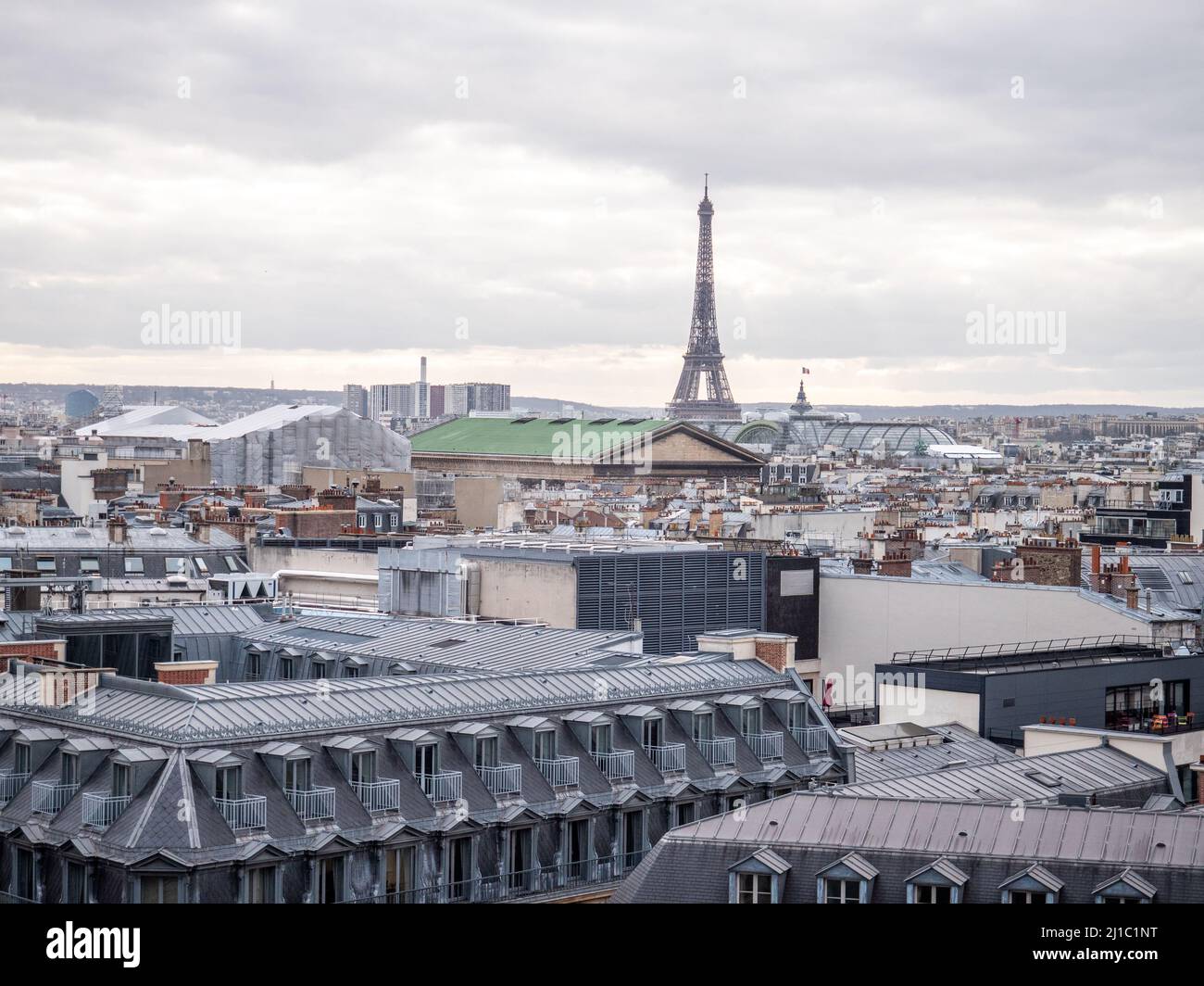 A gorgeous cityscape of Paris under a gray cloudy sky on a gloomy day ...