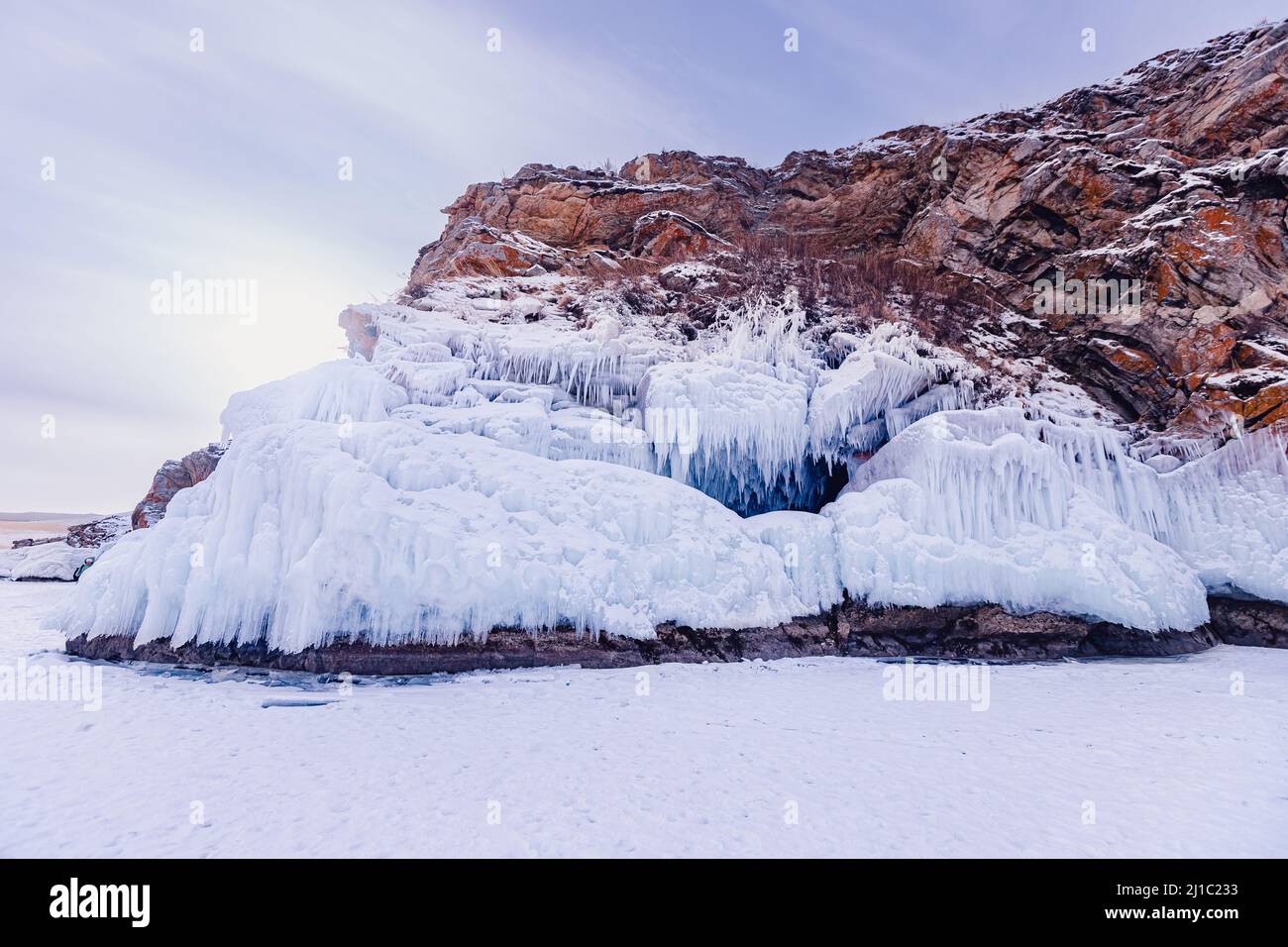 Blue ice cave grotto lake Baikal Olkhon island, Russia. Frozen clear icicles, beautiful winter ...