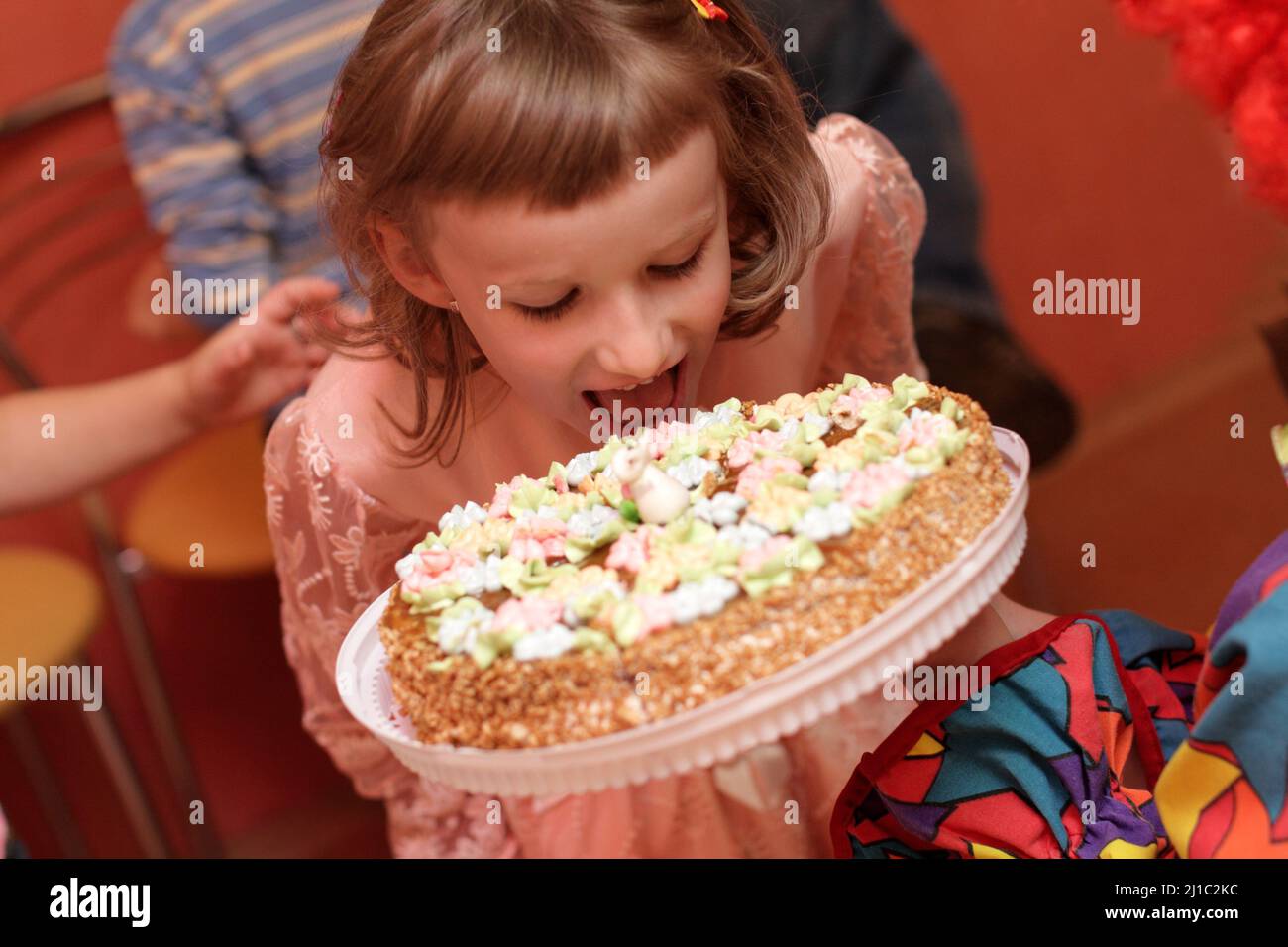 The girl bites a birthday cake at cafe Stock Photo - Alamy