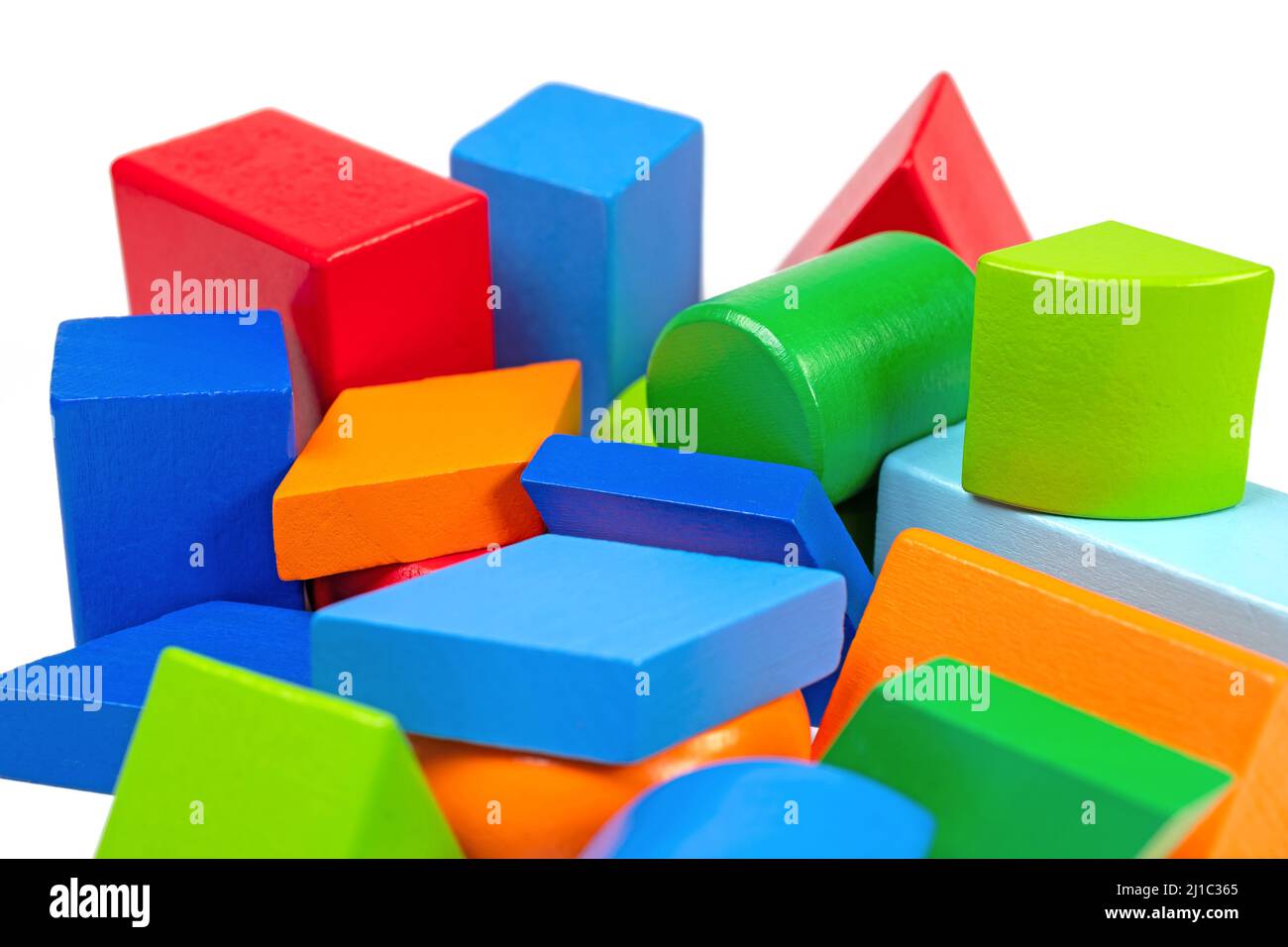 Wooden building blocks of different shapes and colors against a white ...