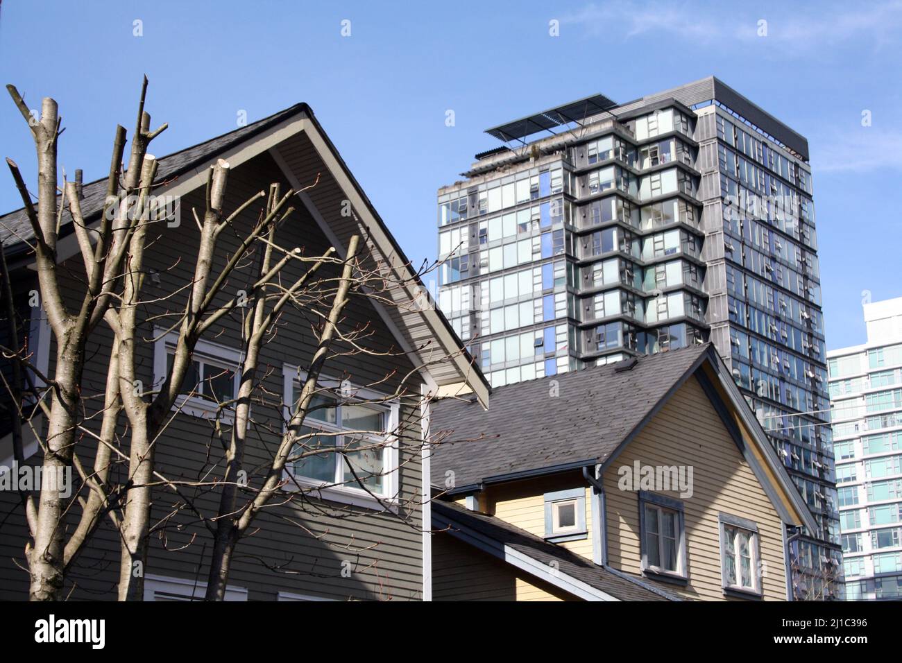 A Old wooden houses and modern high rise residential buildings in ...