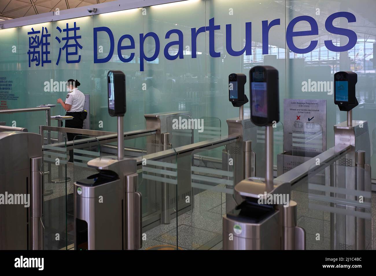 An immigration control officer waits for passengers at Hong Kong ...