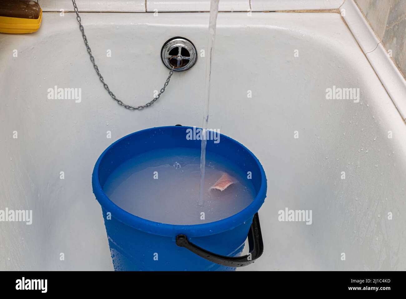 water flowing into the bucket in the bathroom. High quality photo Stock ...