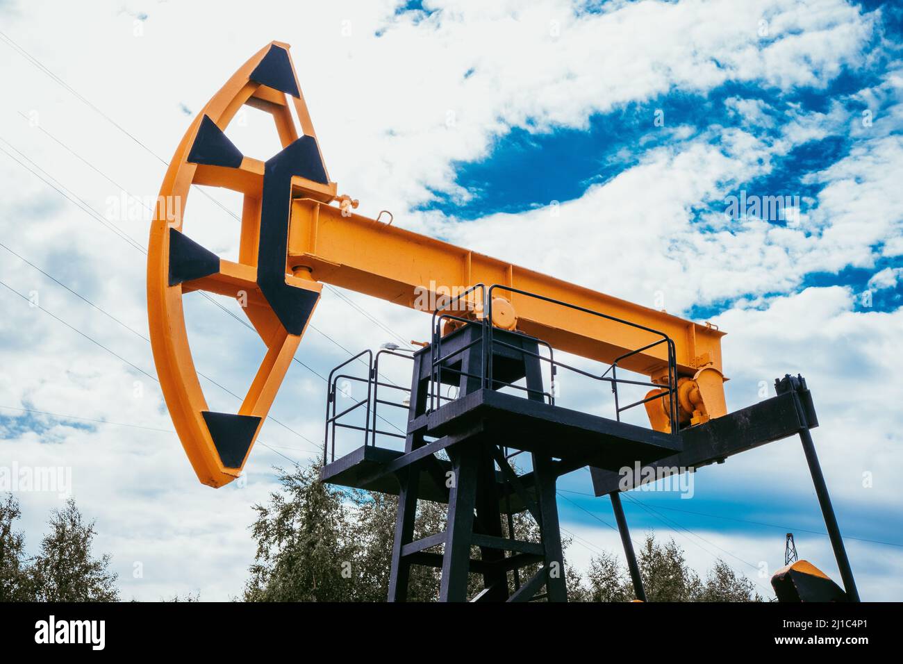 industrial landscape. oil field. Oil pumps against the blue sky. The ...