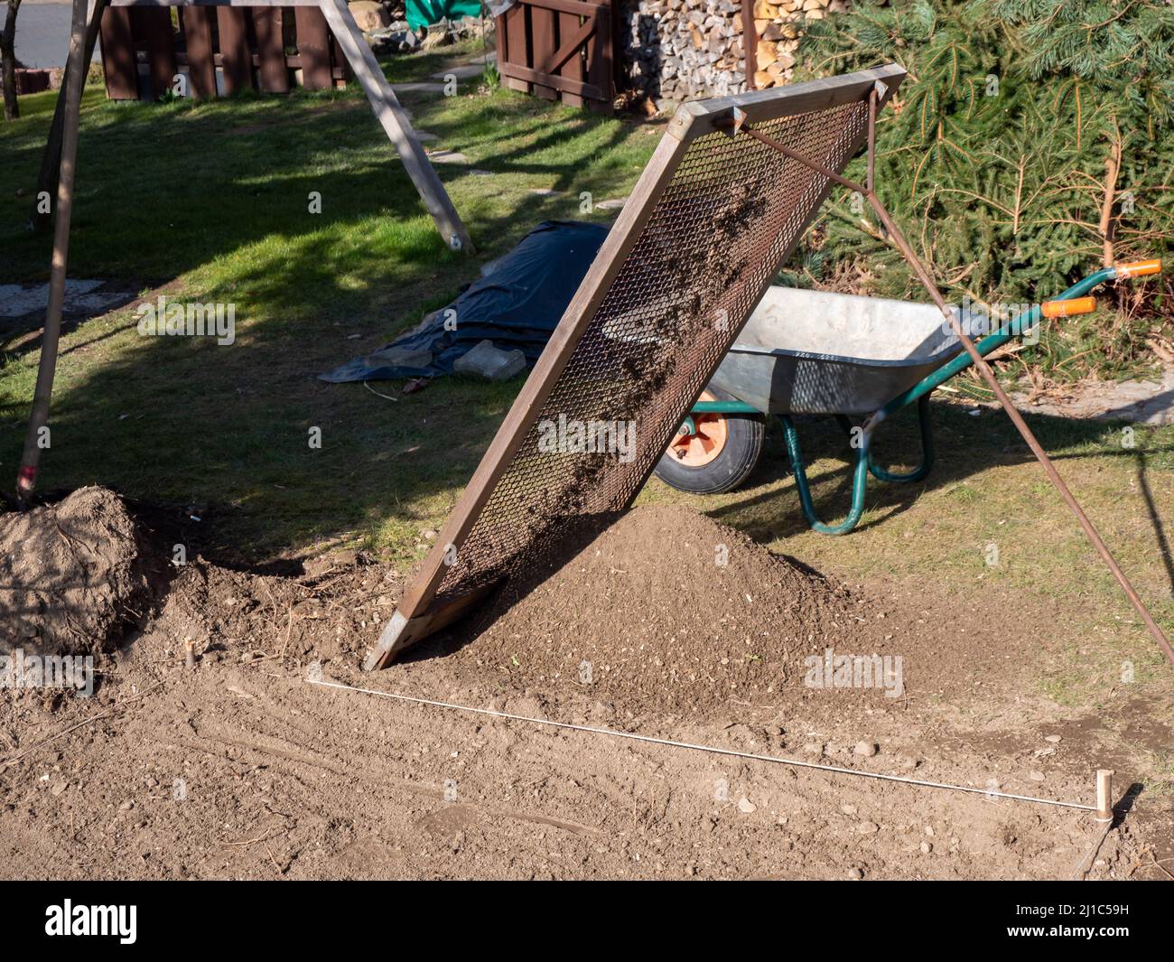 Top soil is sifted in the garden for recycling Stock Photo - Alamy