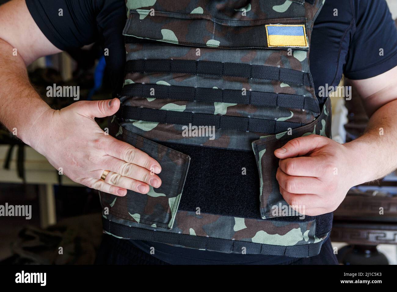 A man demonstrates an armored vest made of leaf springs, Zakarpattia ...