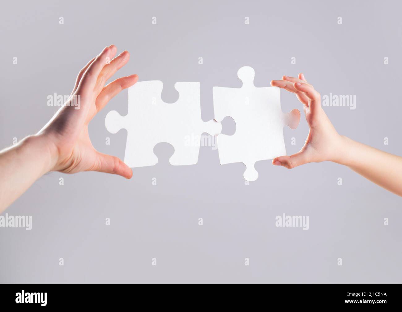 Mens and childs hands connecting puzzles. Hands connecting puzzle ...
