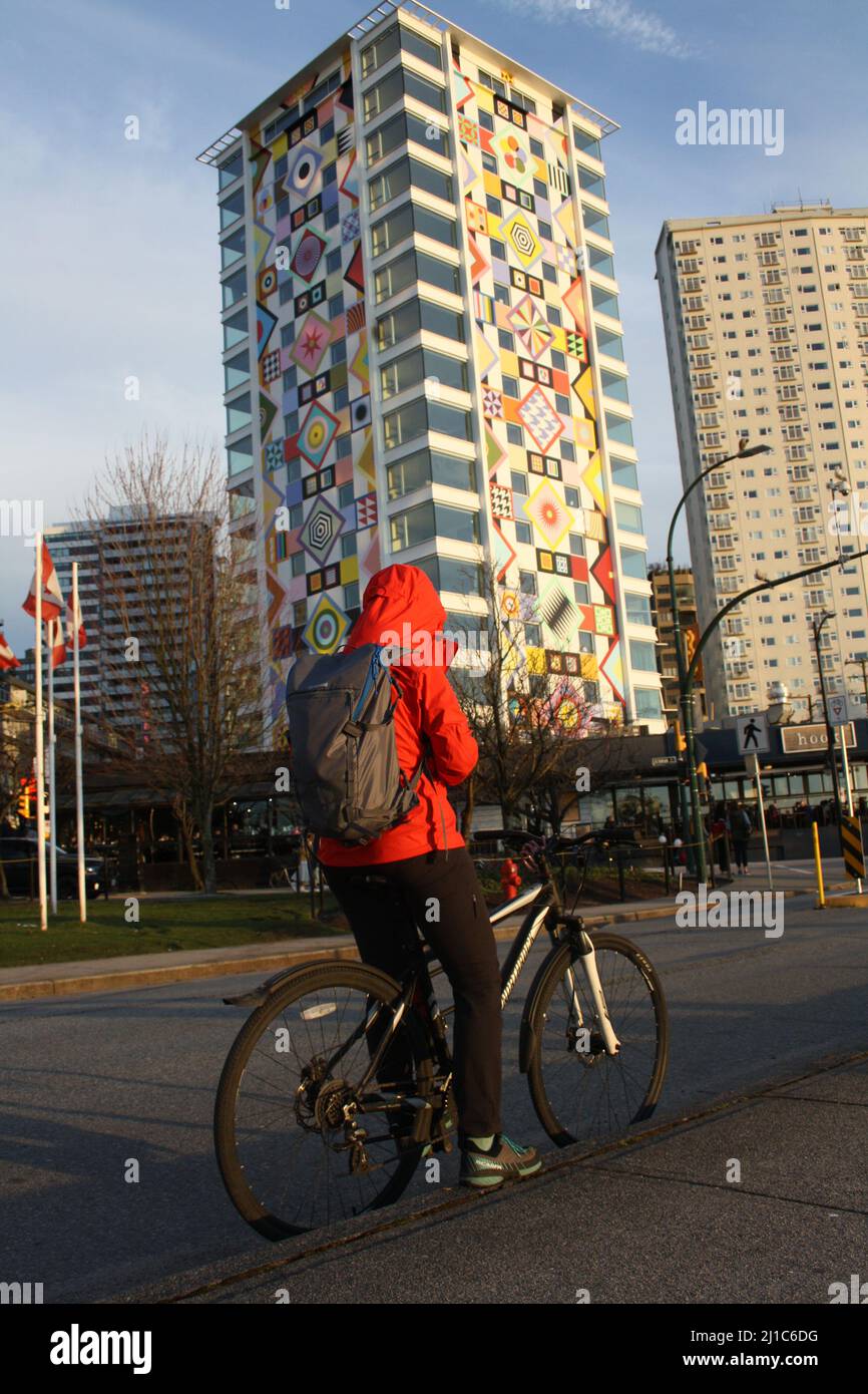 A vertical shot of a colorful high-rise residential building and a ...