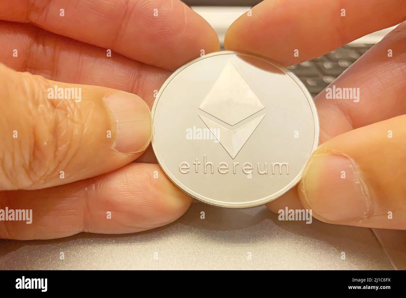 a Close up physical coin of cryptocurrency in hands Stock Photo - Alamy