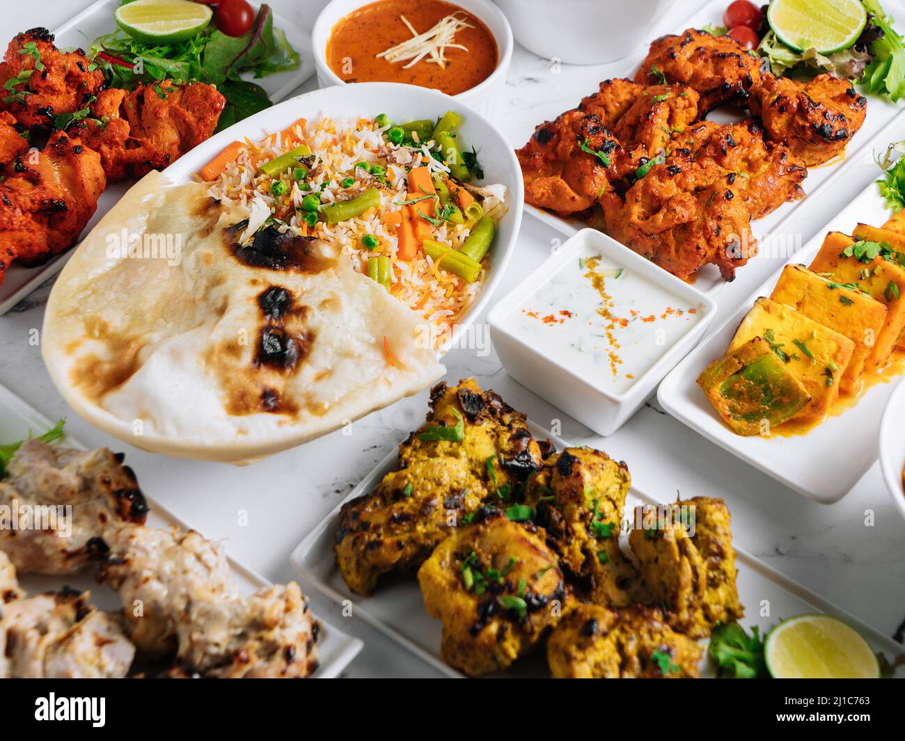 Assorted famous indian and pakistani food table vegetable biryani ...