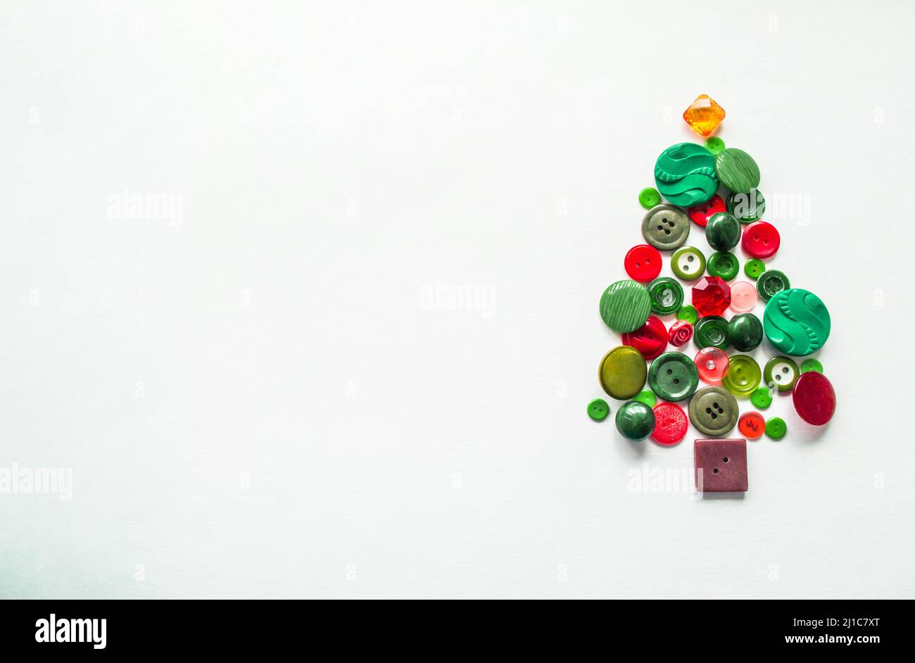 Tree made of buttons of green, red color. white background, copy space ...