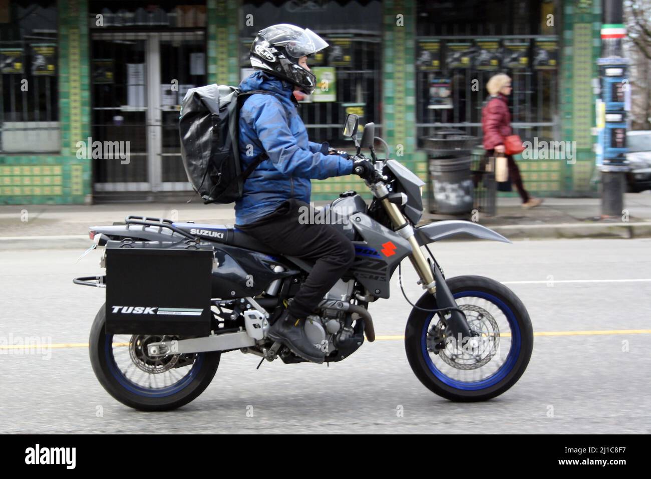 A motion view of food delivery motorcycle rider in helmet in the East ...