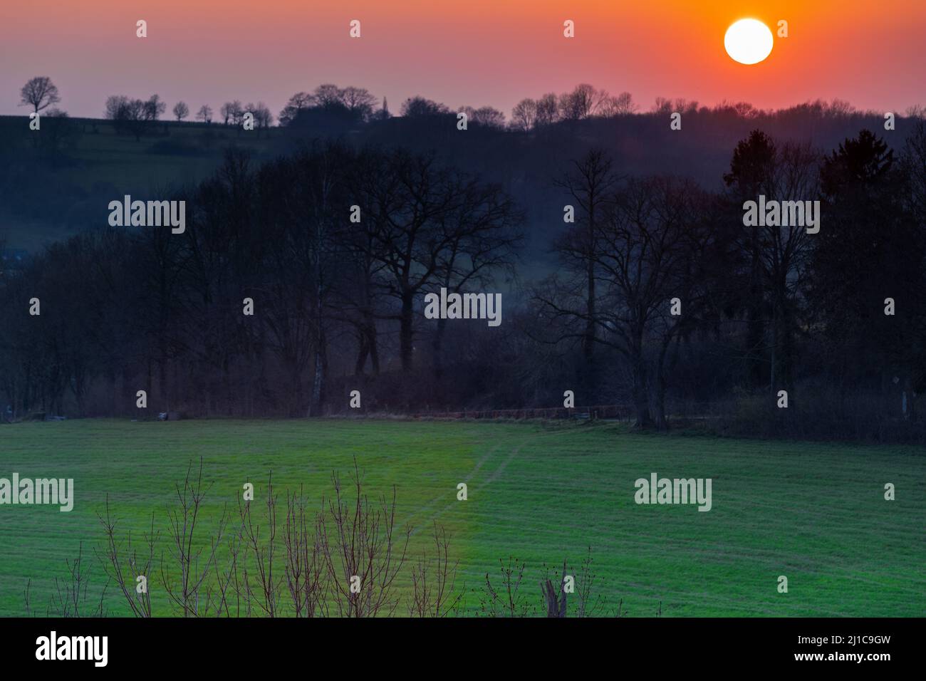 A sunset during spring over het rolling hill landscape in the south of ...