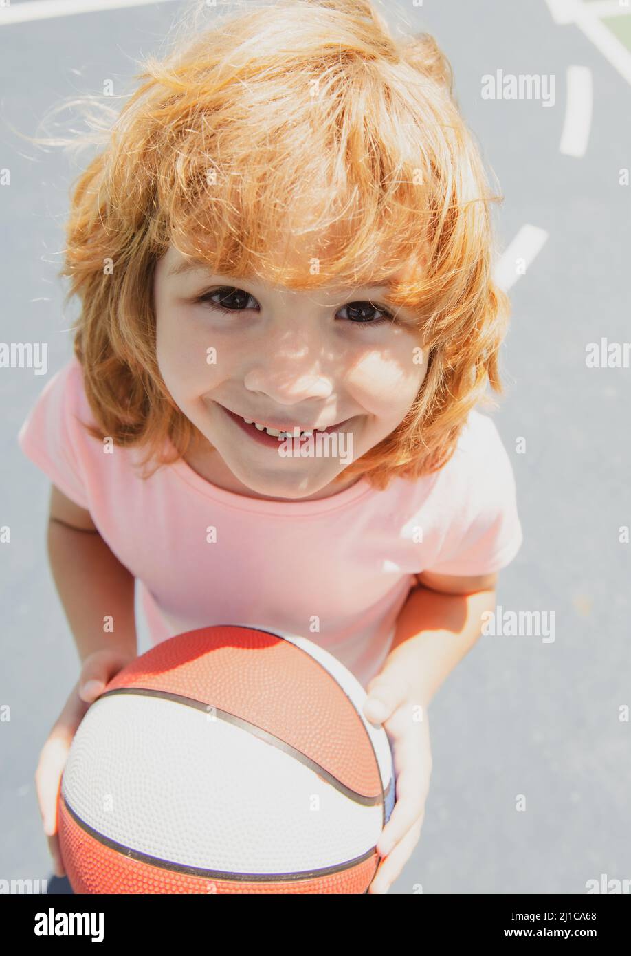 Funny child play basketball. Kids head portrait Stock Photo - Alamy