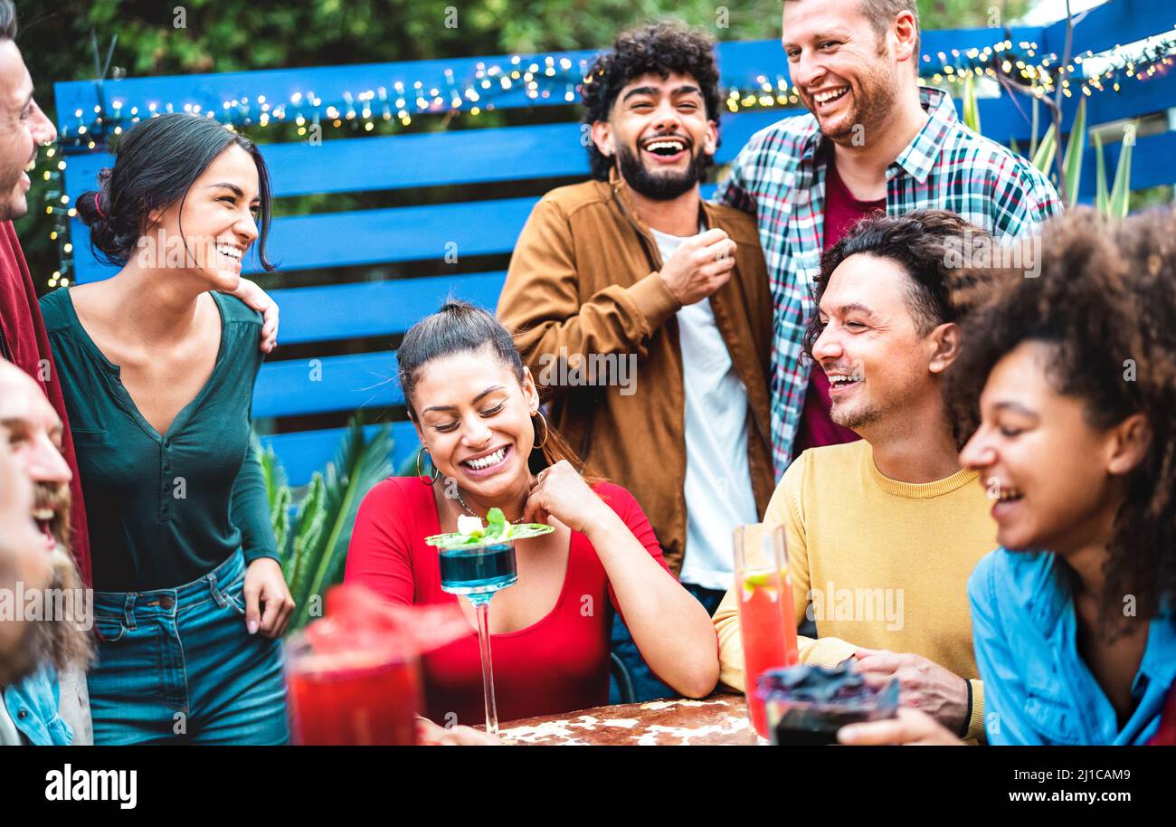 Millennial trendy people having fun moment at fancy cocktail bar patio ...