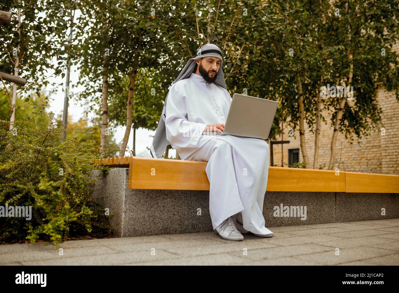 Concentrated arabian man working laptop hi-res stock photography and ...