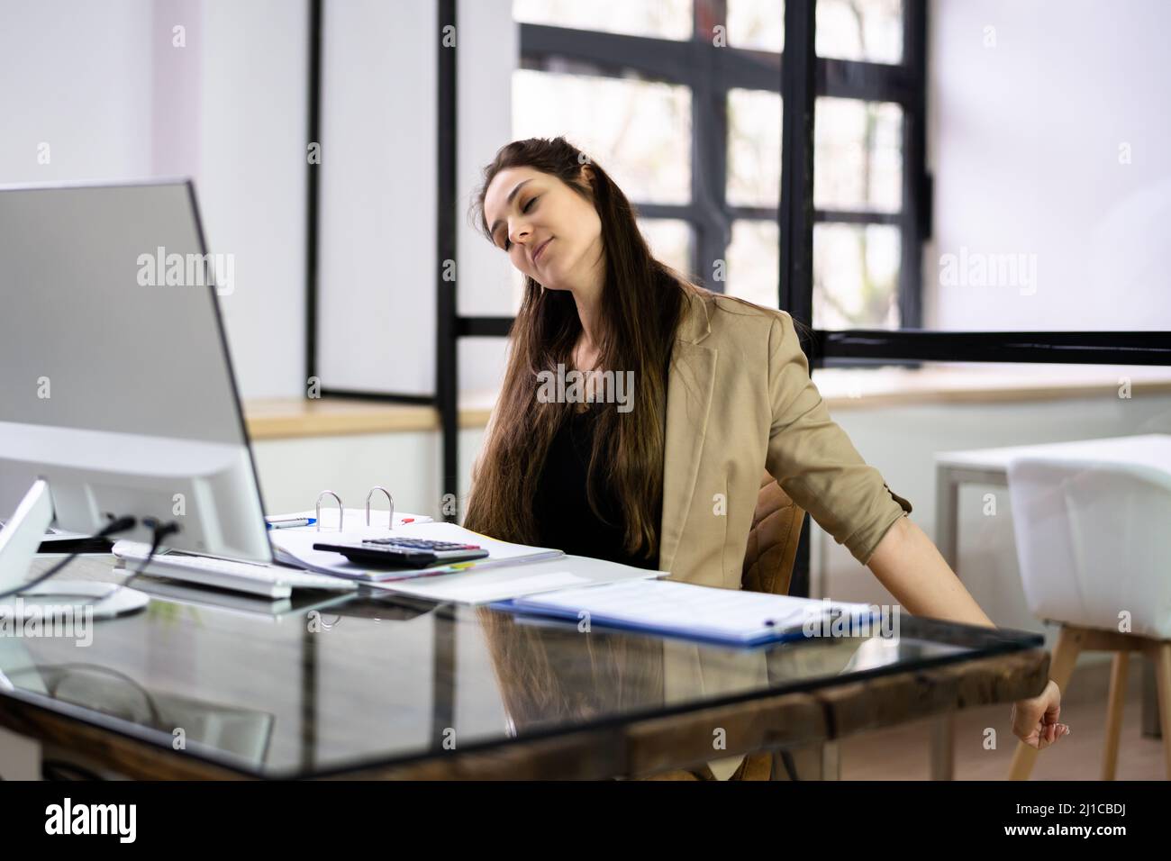 Work From Home Stretch Exercise At Computer Desk Stock Photo - Alamy