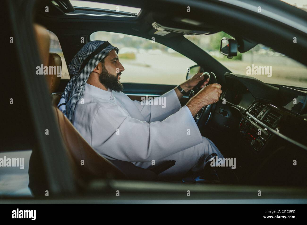 Saudi man driving a car and feeling good Stock Photo - Alamy