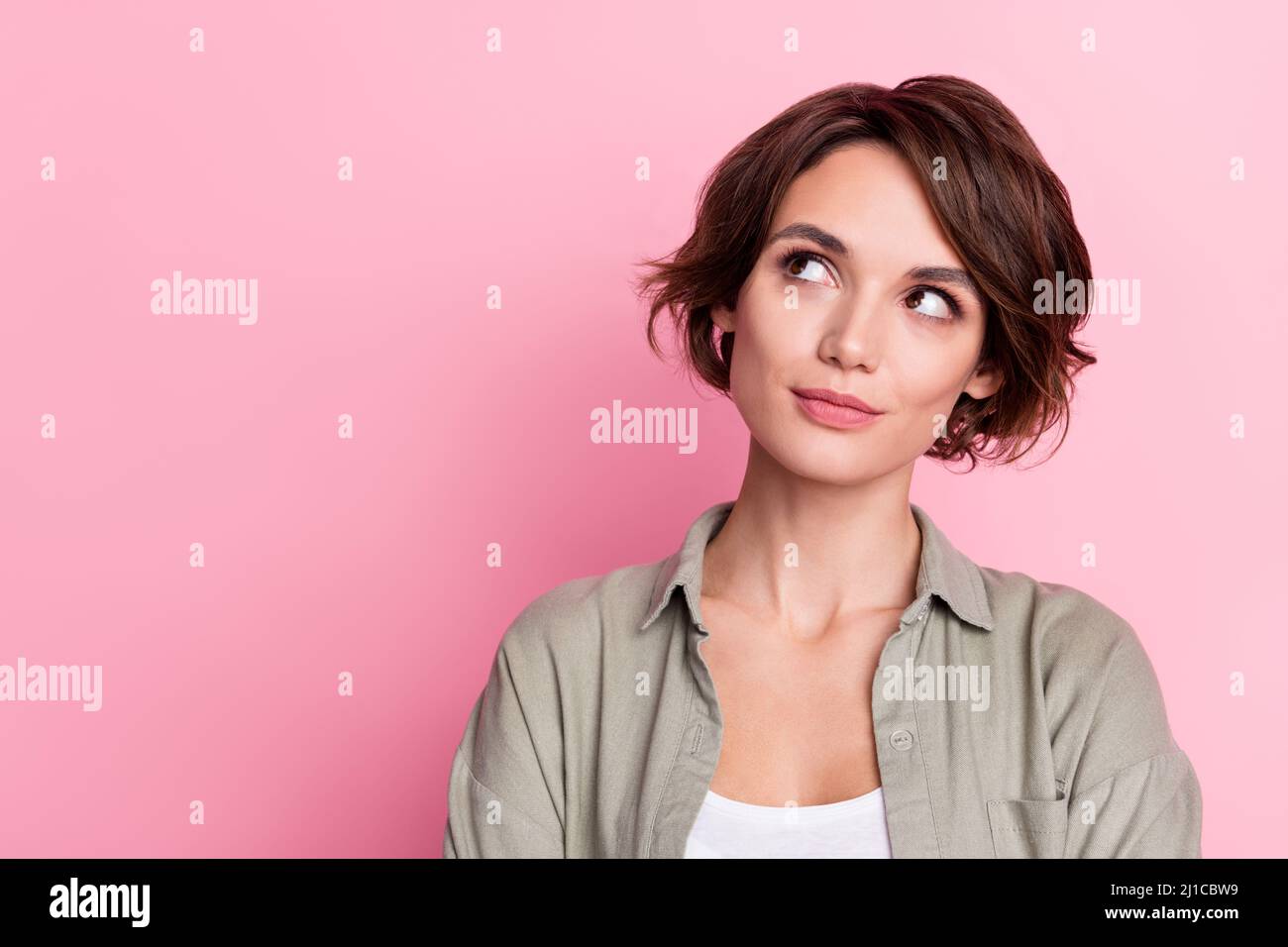 Photo of cute millennial bob hairdo lady look empty space wear grey ...