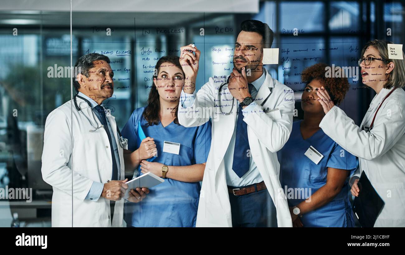 Medical brainstorming brilliance. Shot of a team of doctors having a ...