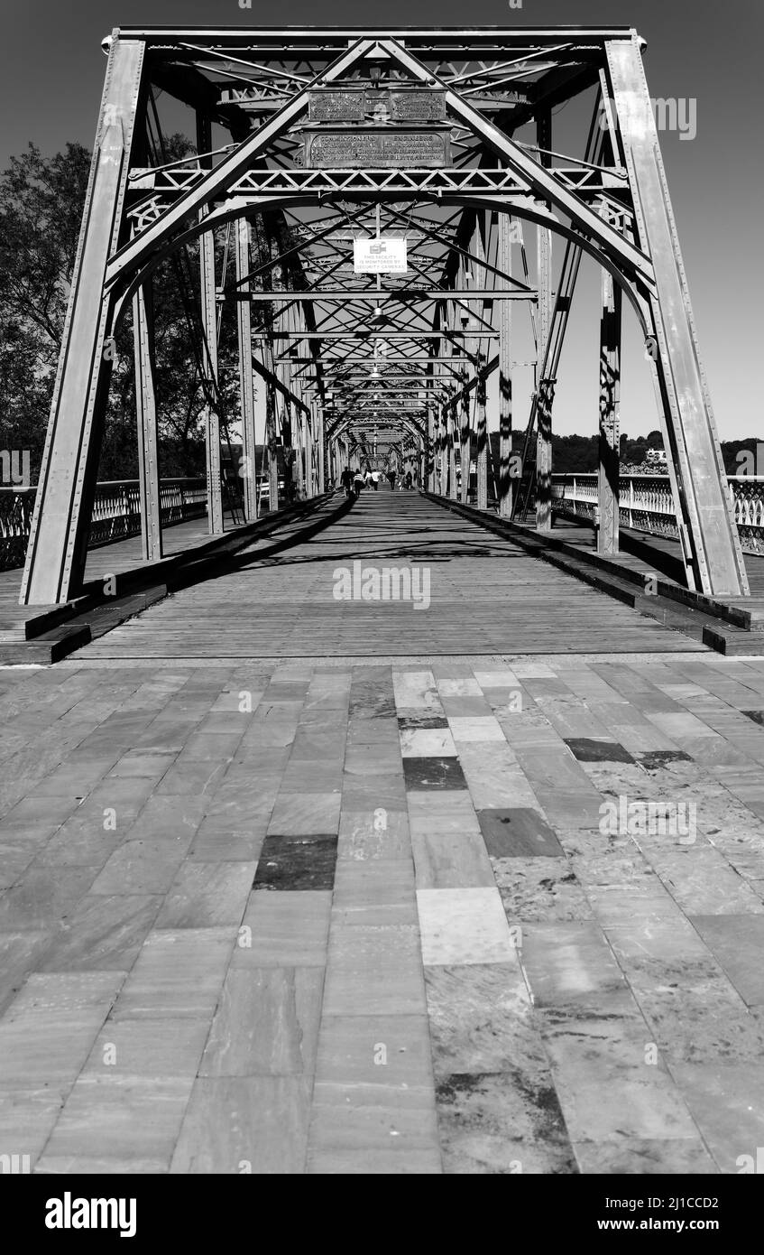 A grayscale view of a modern steel bridge in the city during daytime ...