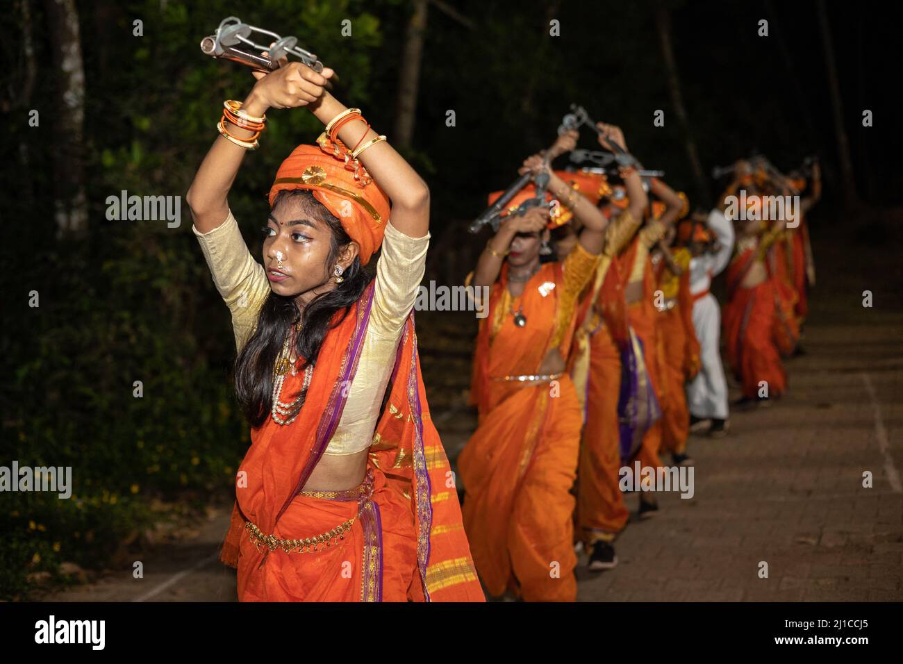 Women of all age group in traditional attire, dancing while playing a ...