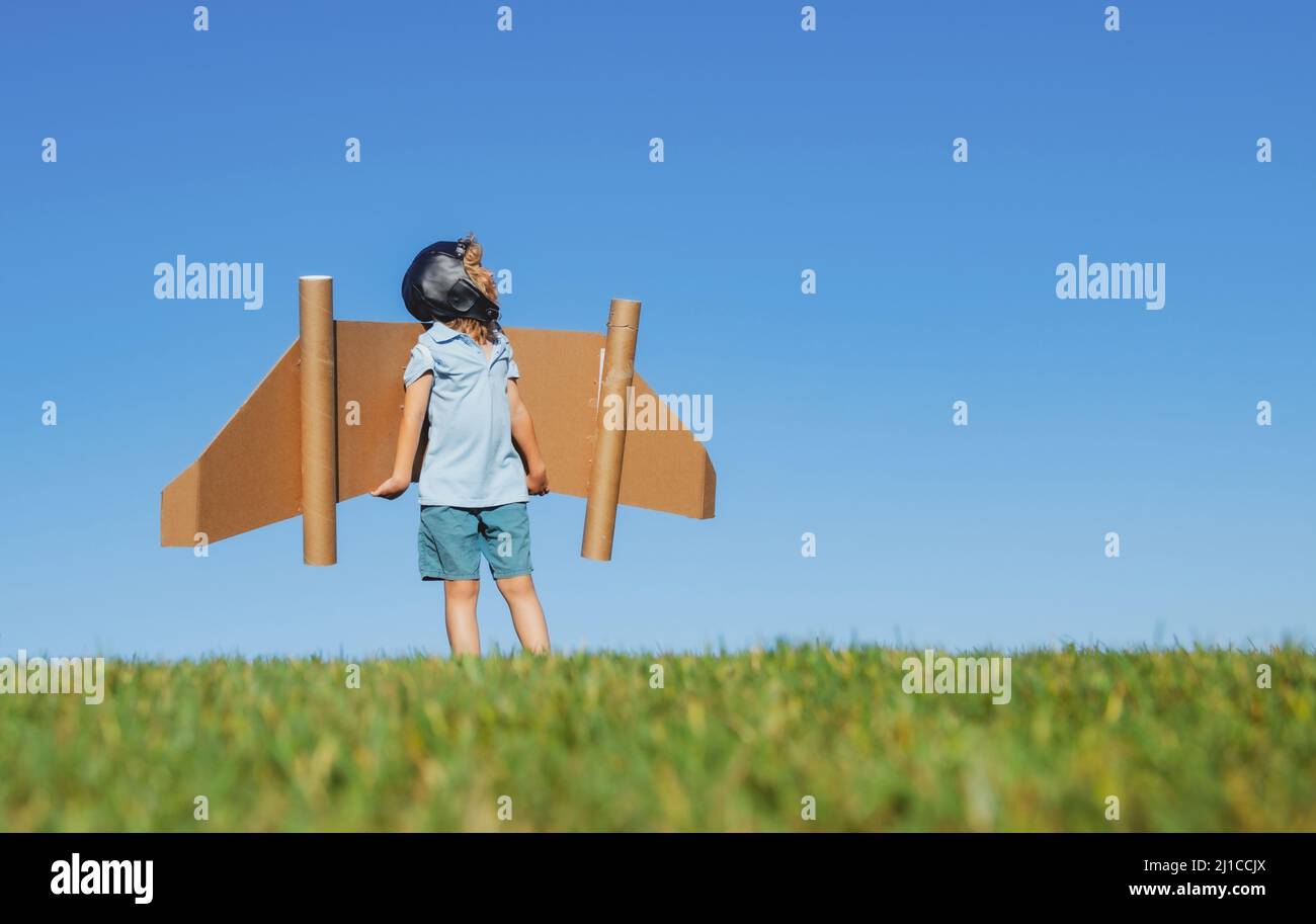 Happy child playing with toy jetpack. Kid pilot having fun outdoor ...