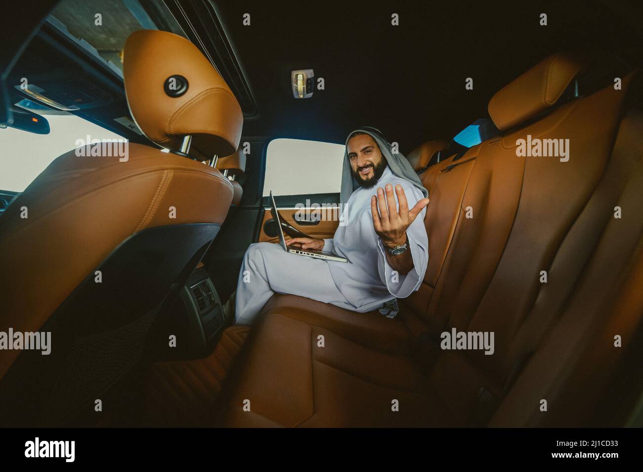 A young rich saudi in a leather car interior Stock Photo - Alamy