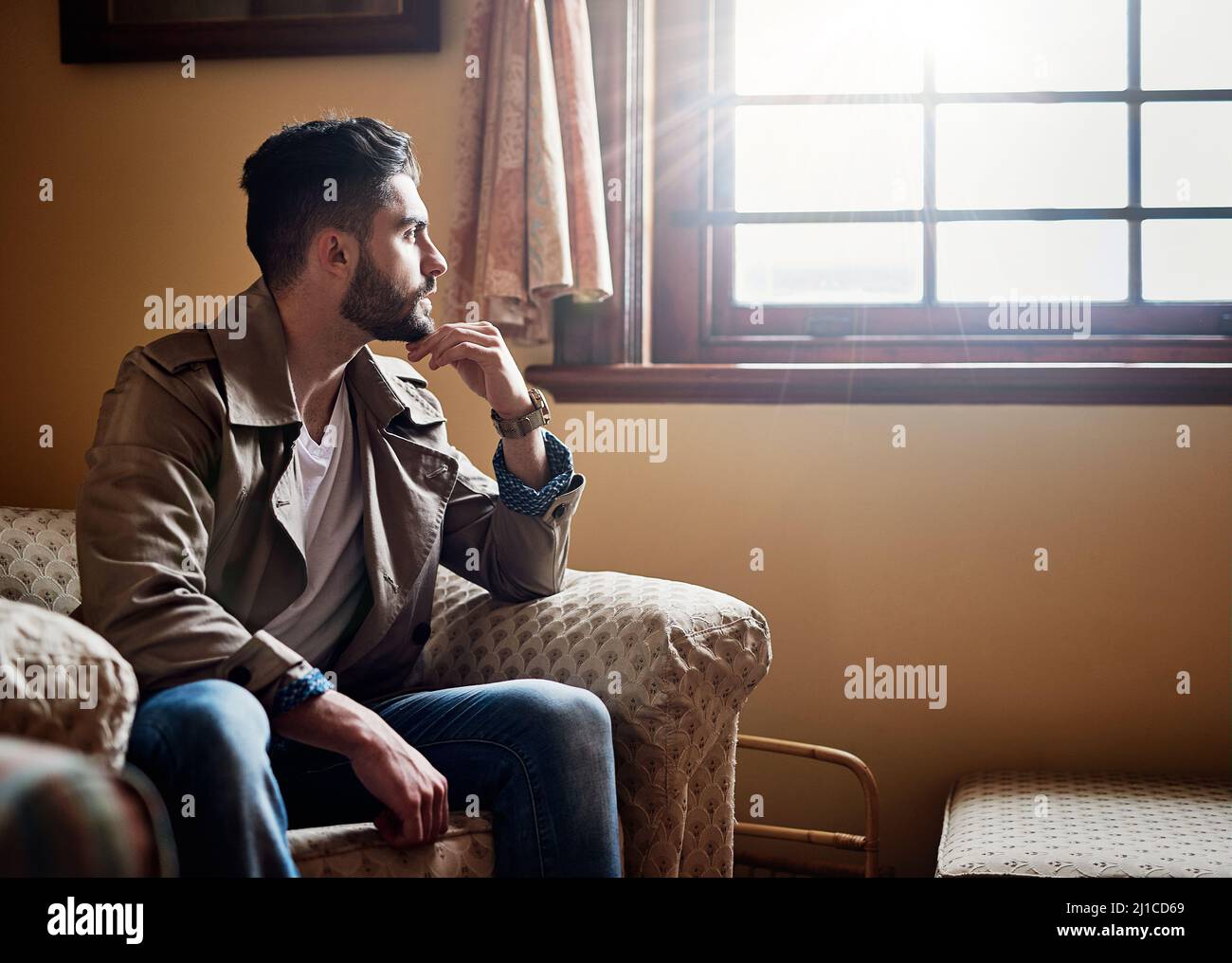 Thinking things through.... Shot of a handsome young man deep in ...